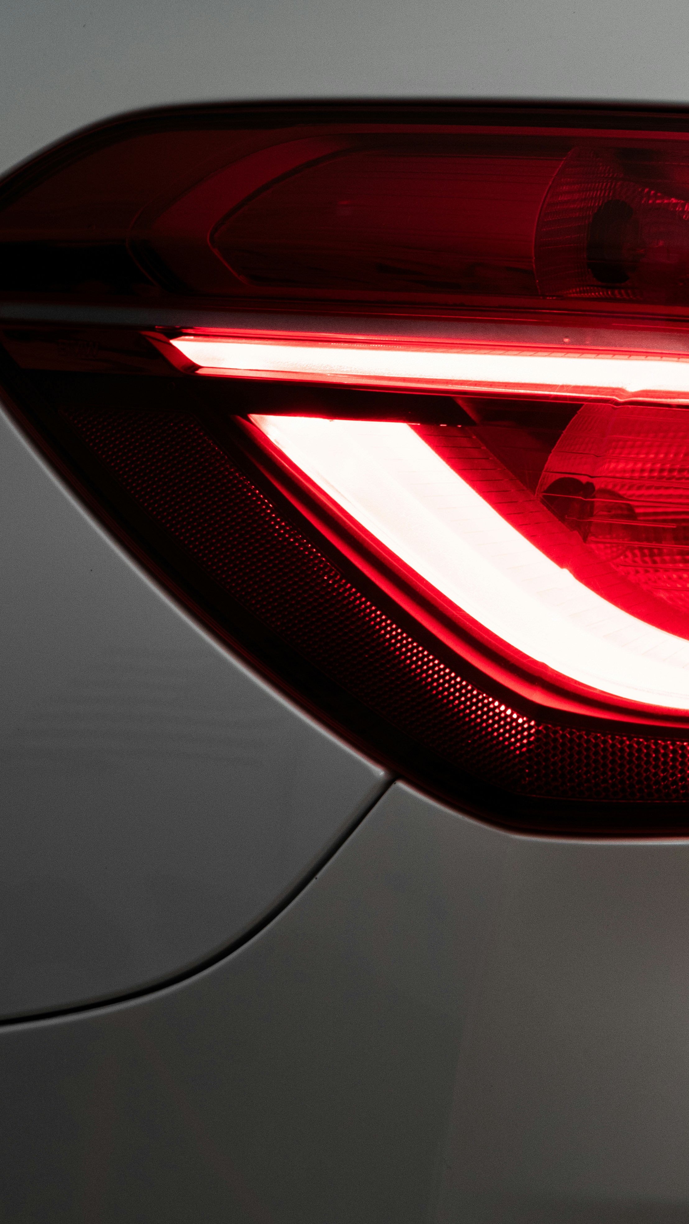 Neon Red Taillight Curve: A Close-Up of Modern Car Tail Design