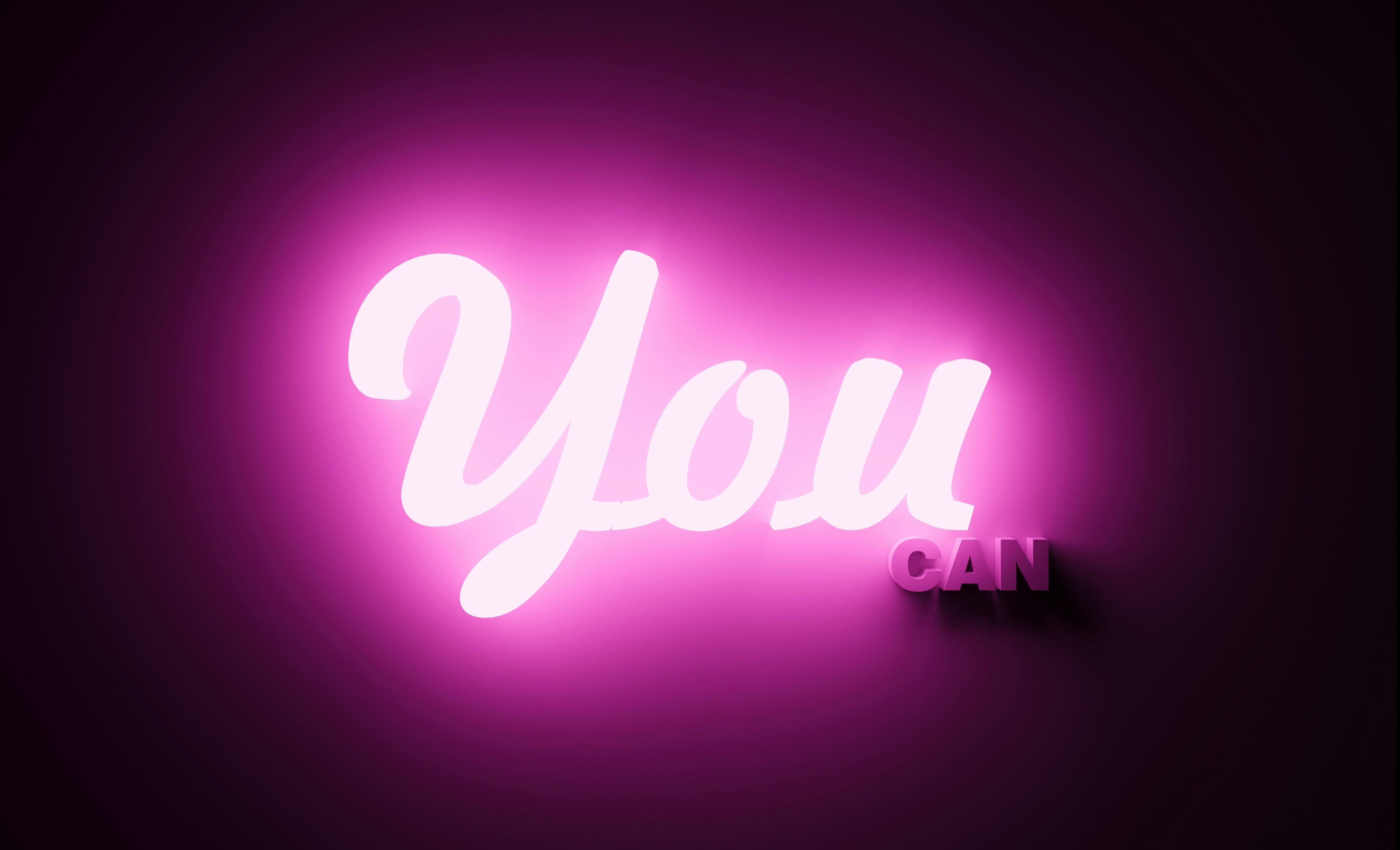 A bright pink neon sign reading "You" with the word "CAN" below