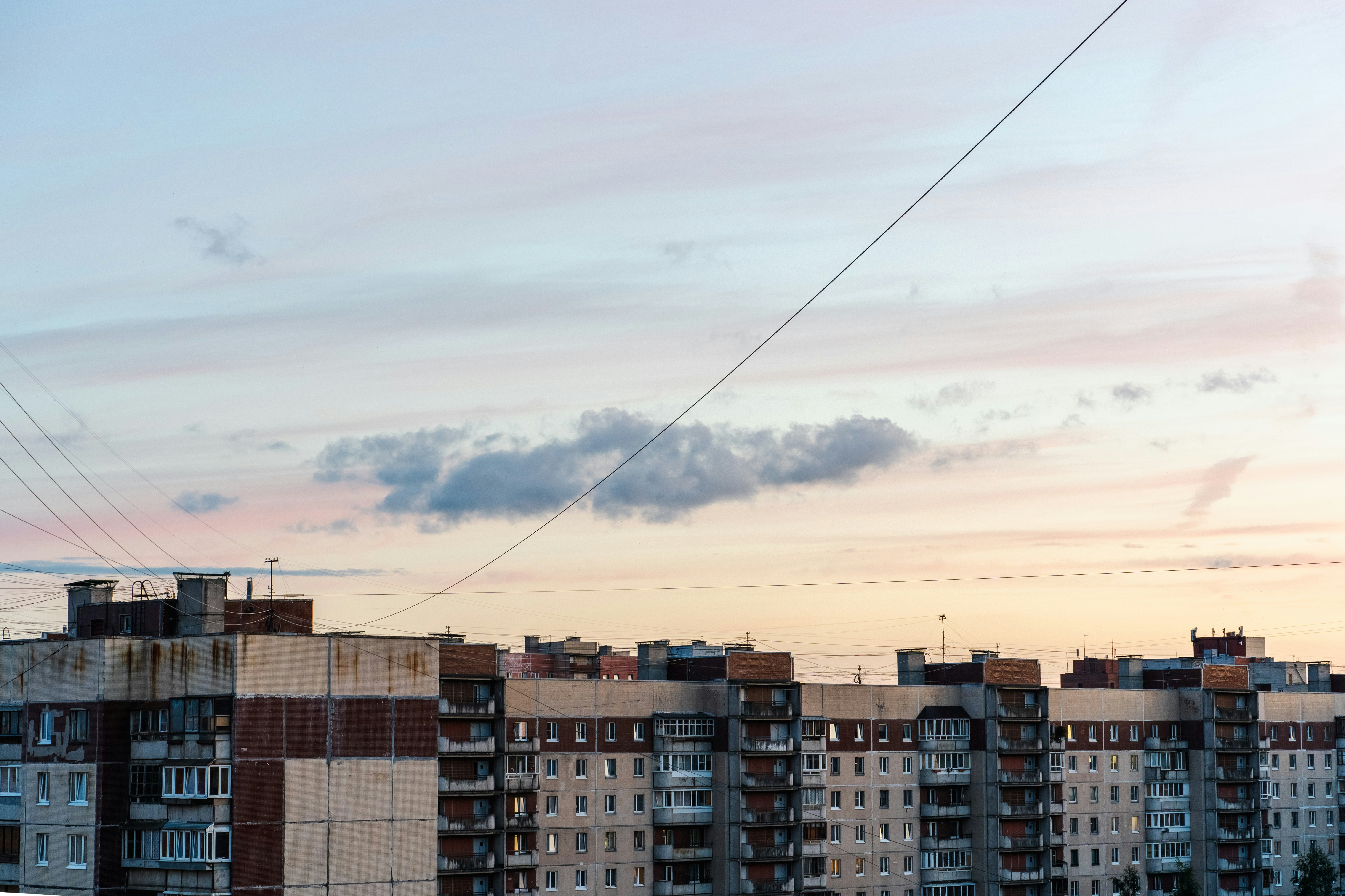 Distant Apartment Row at Dusk Under Power Lines