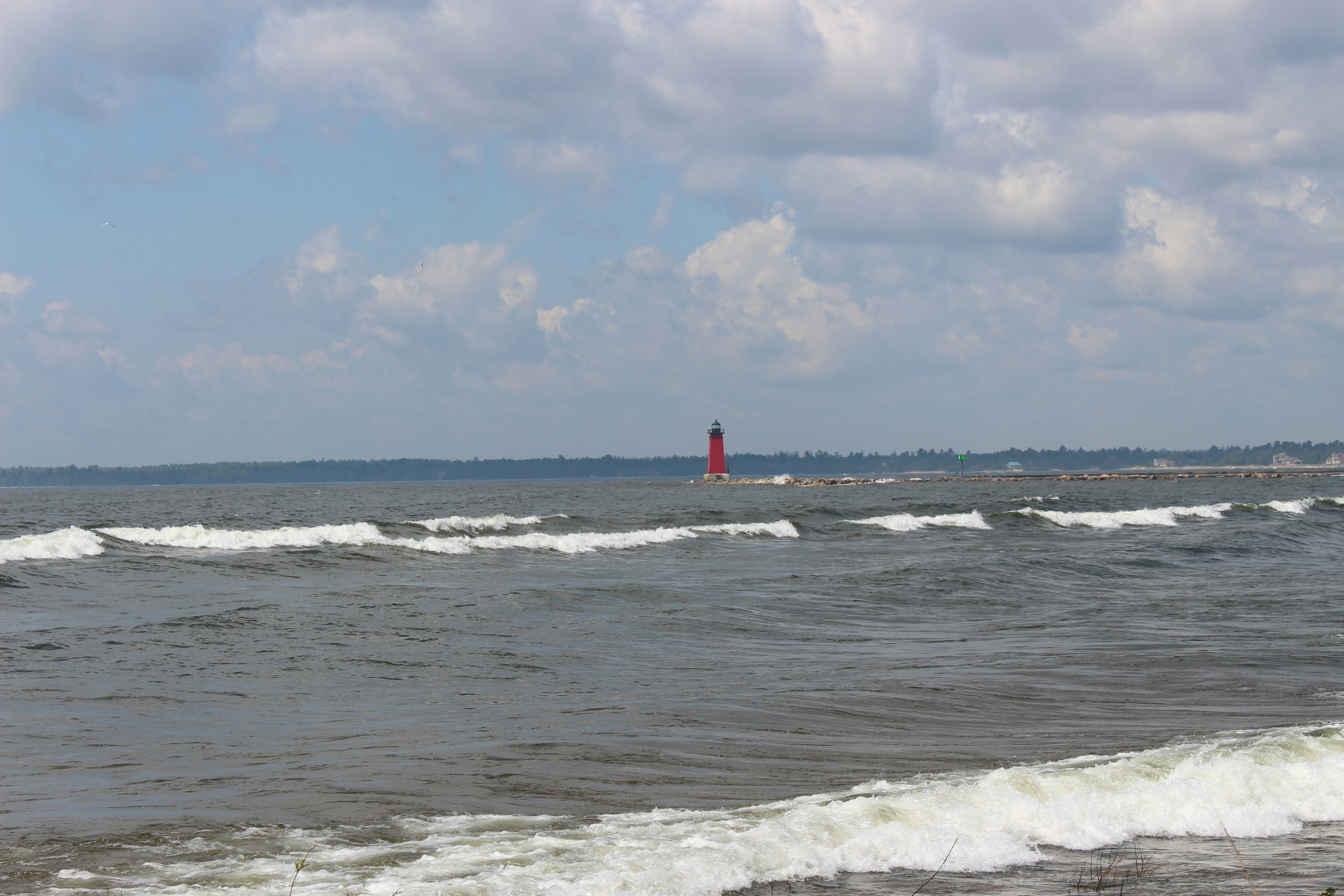 A distant beacon over rolling sea