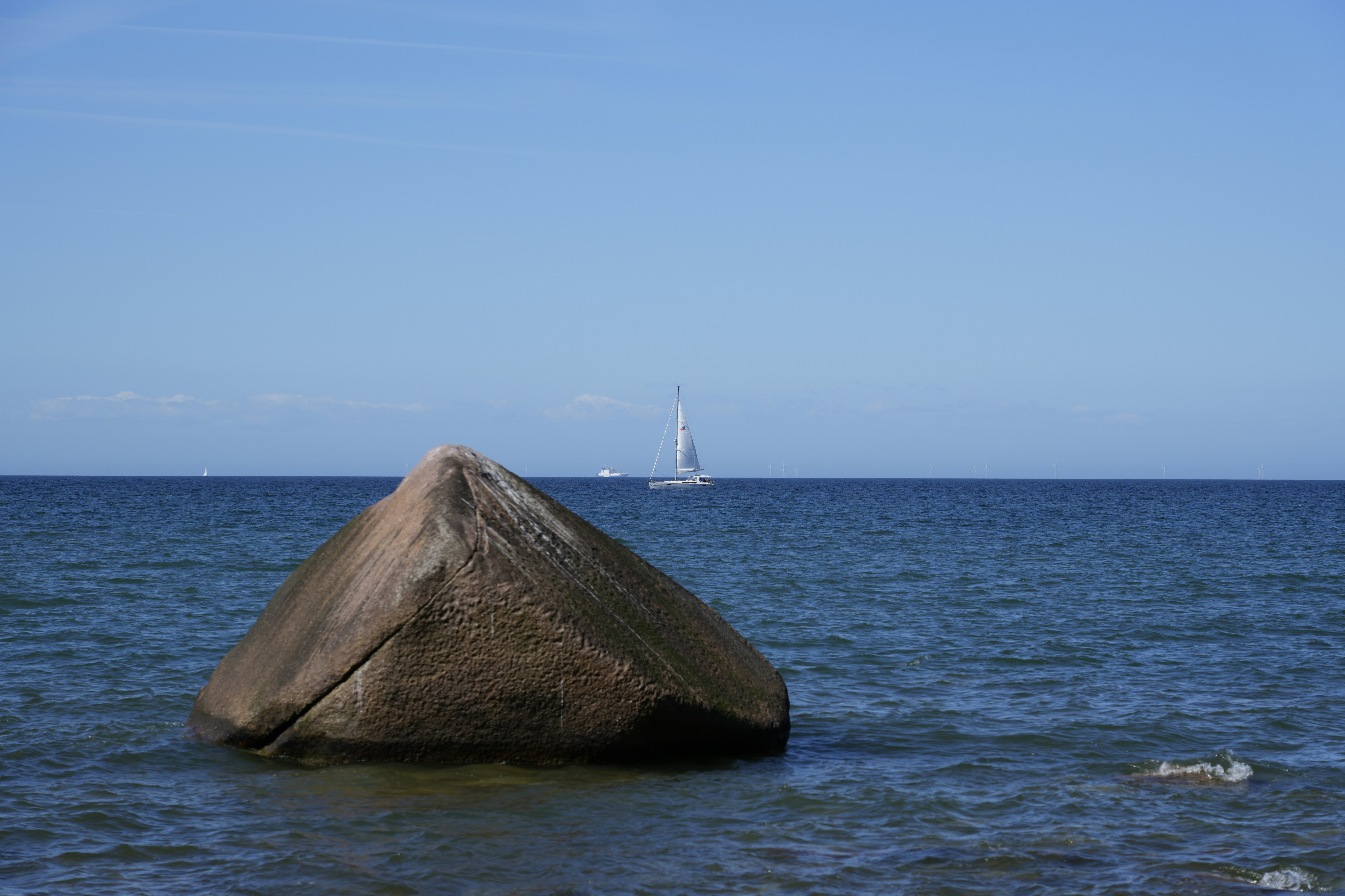 Stone Sentinel at Sea: A Lone Rock Against the Open Horizon