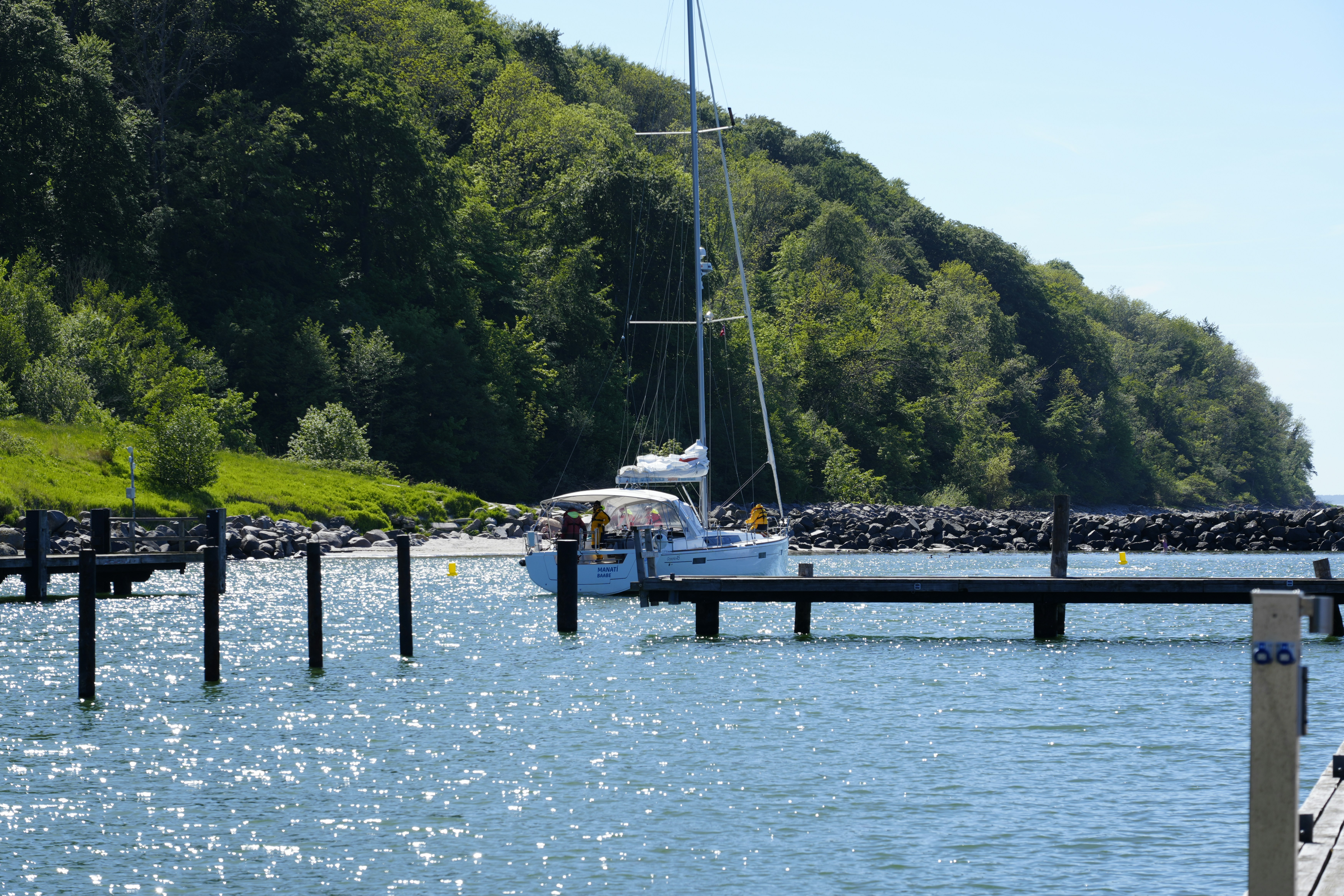 Docked Sloop at Sunlit Lake