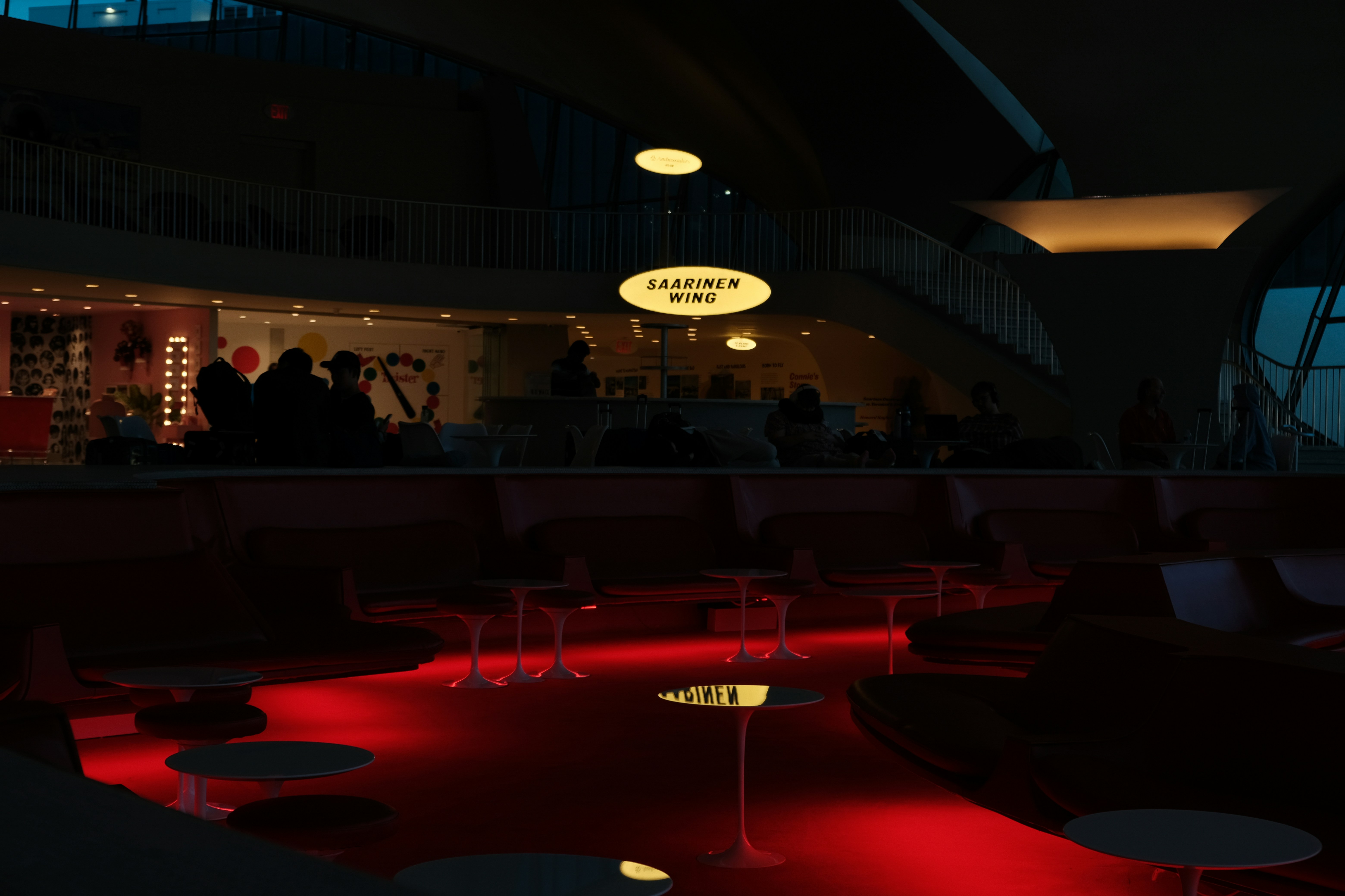 Dim Red Lounge: Quiet Circulation Under a Soft Halo