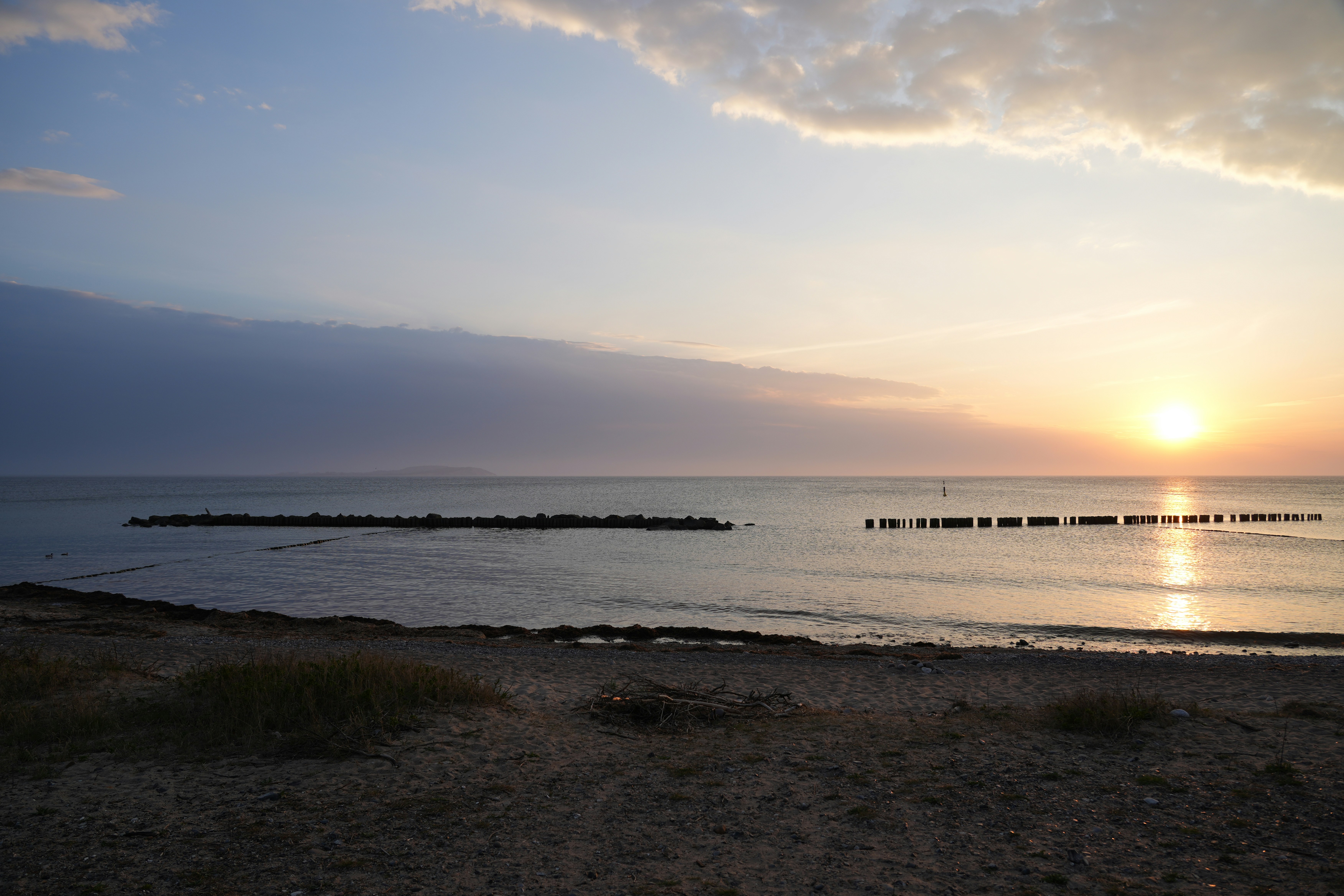 Sunlit Breakwater at Dusk