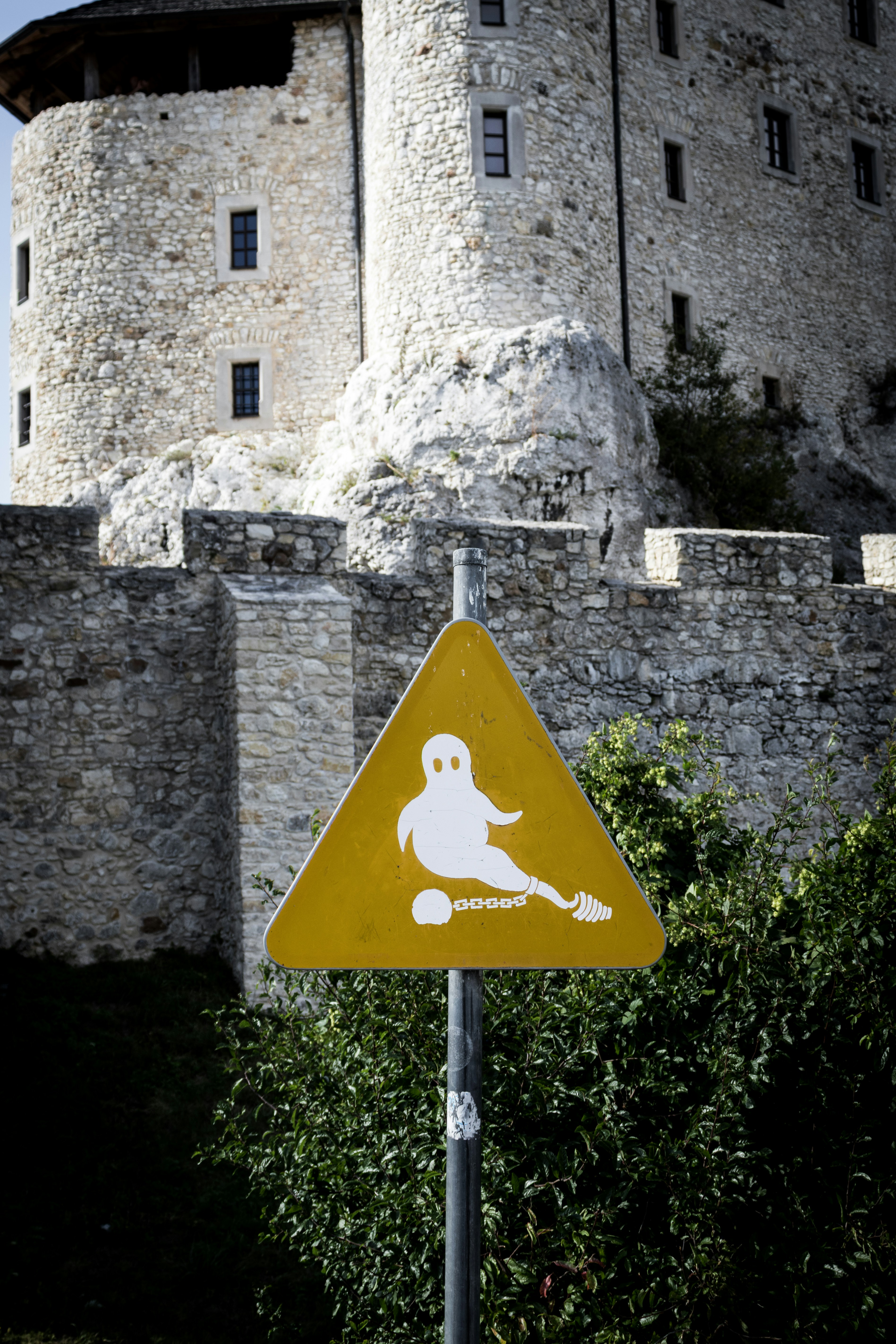 Yellow Warning in Front of a Stone Castle