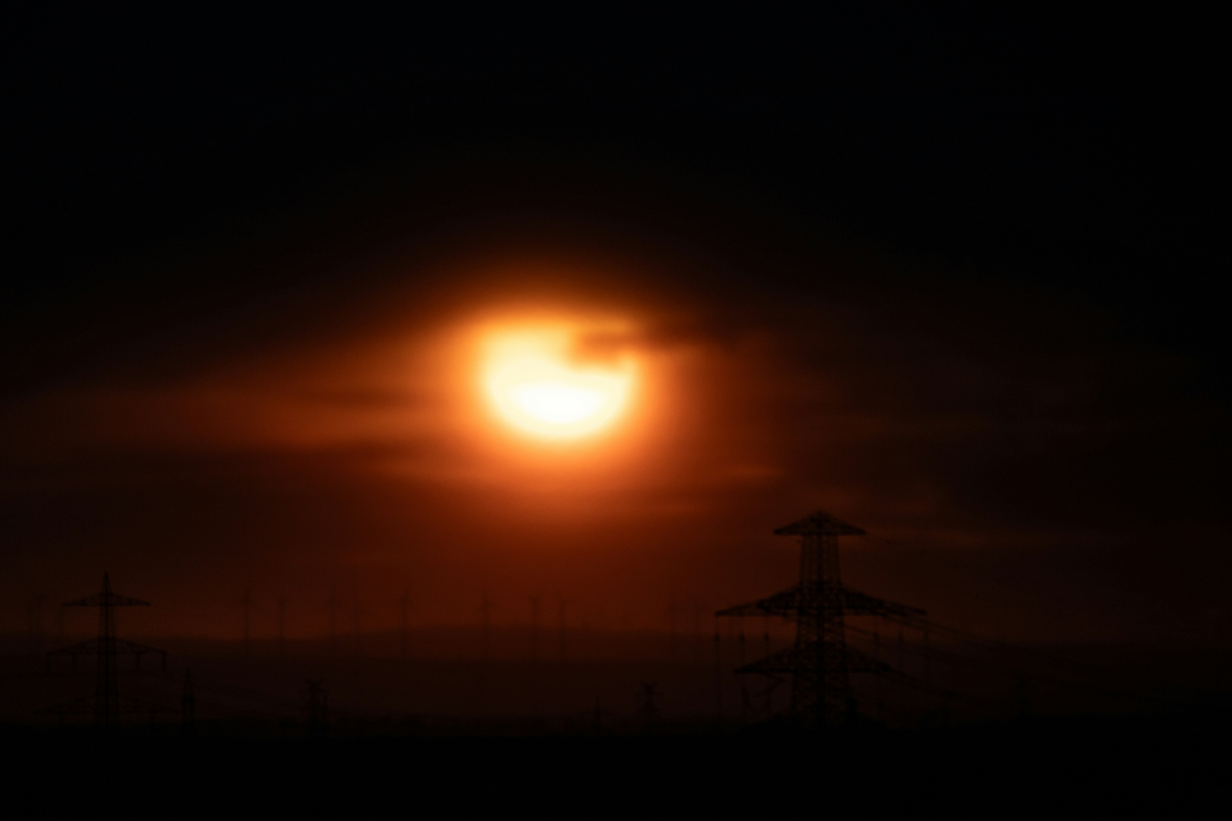 Fiery Horizon: A Silent Sunset Over Power Lines