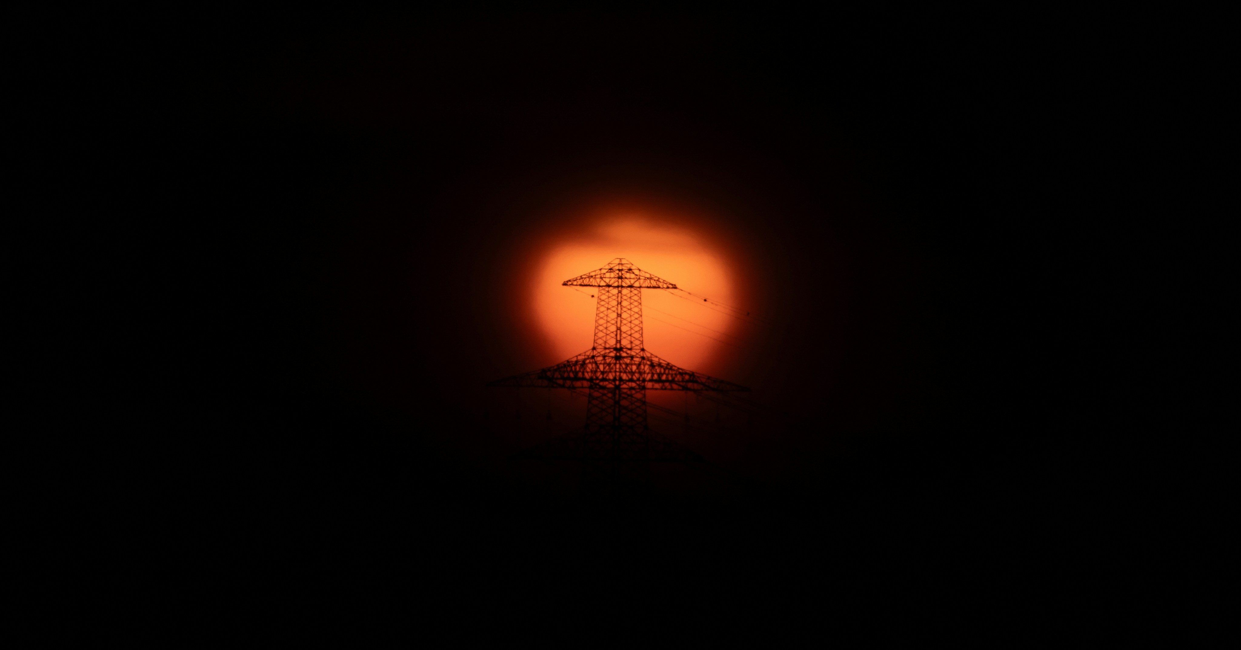 Red Peak of Power: A Tower Silhouette Against a Moonlit Ember