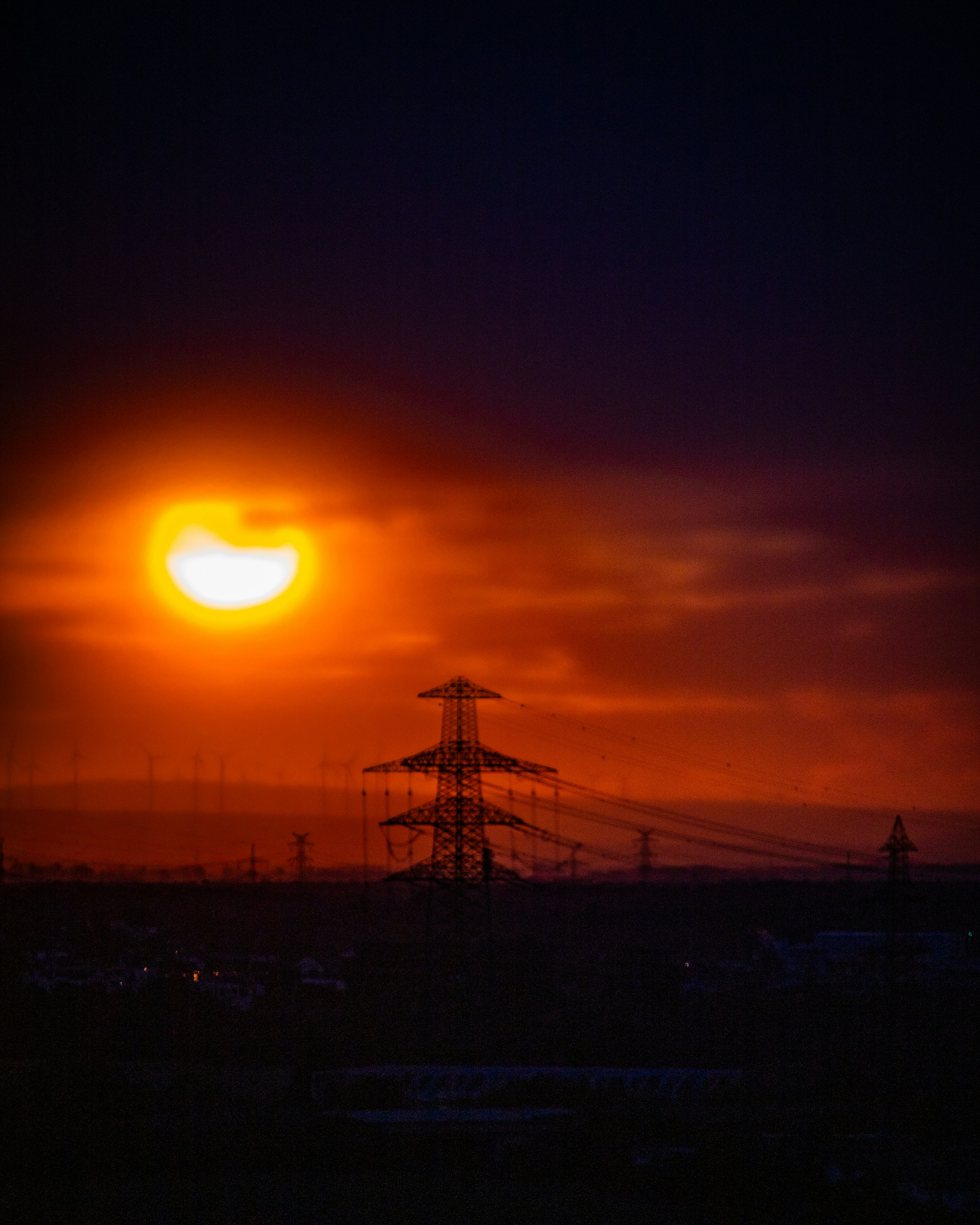 Solar Ember Over Horizon: A Distant Grid Basks in Dusk