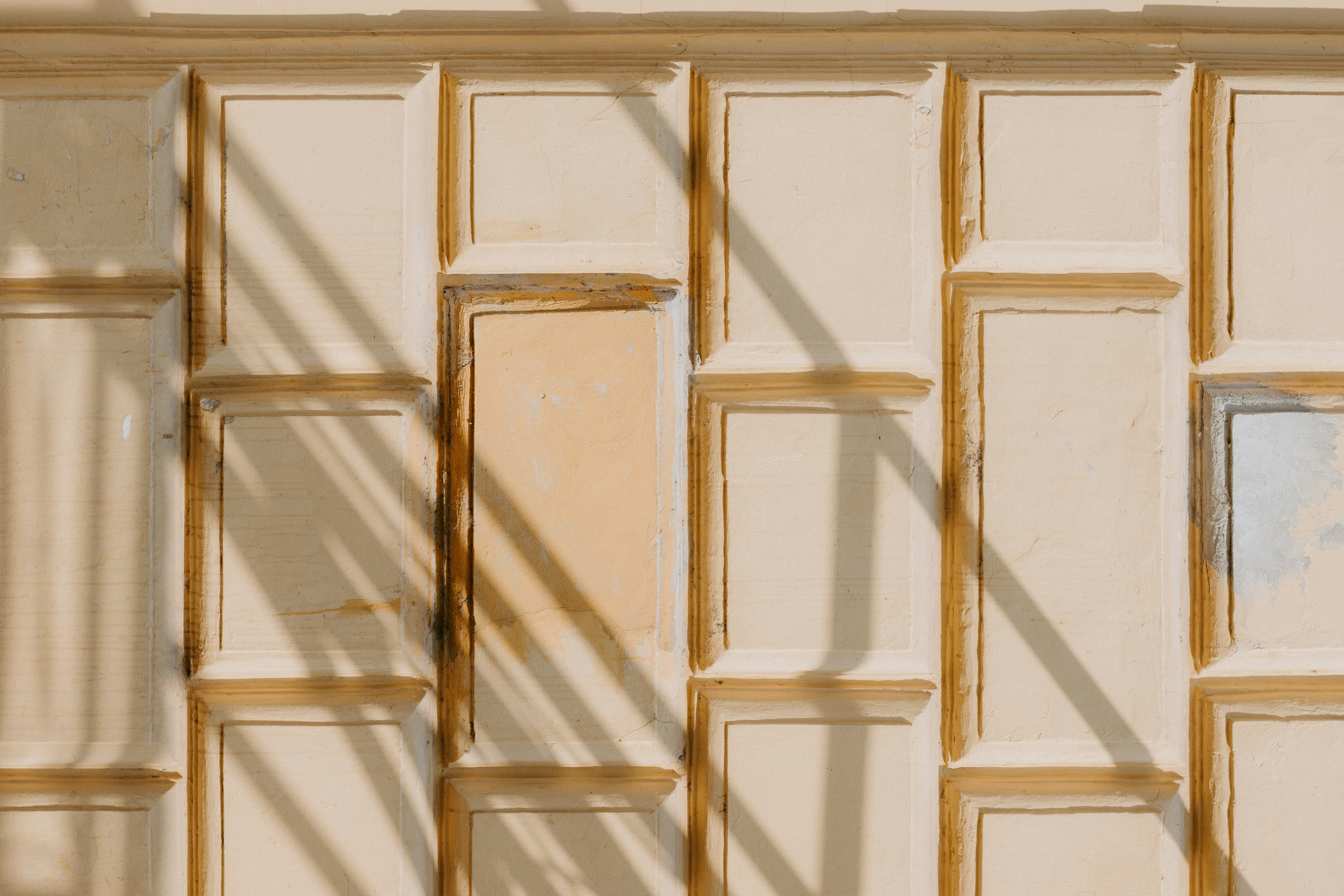 Shadowed panels and diagonal lines on a sunlit facade