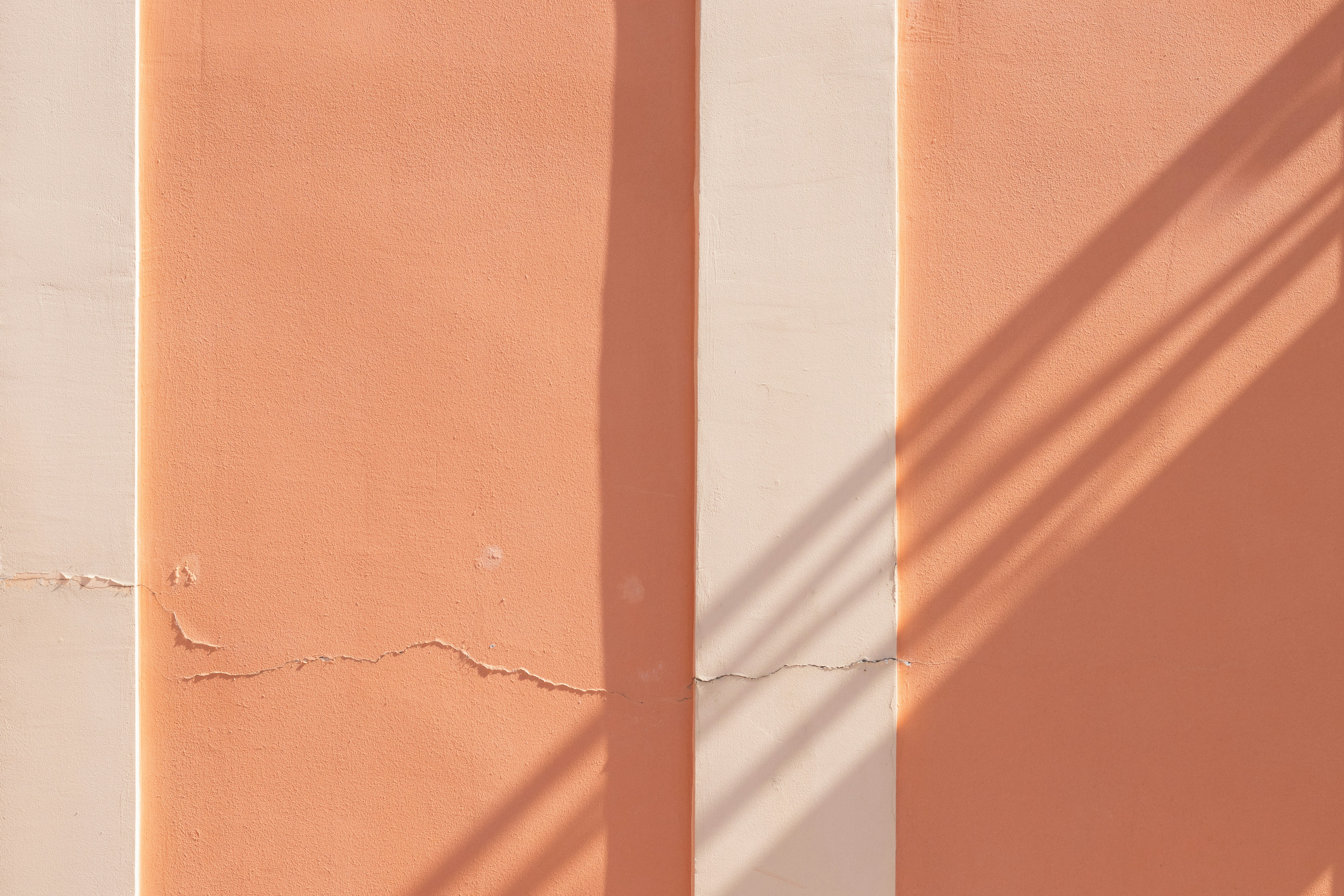 Shadowed Stripes on Warm Terracotta Wall