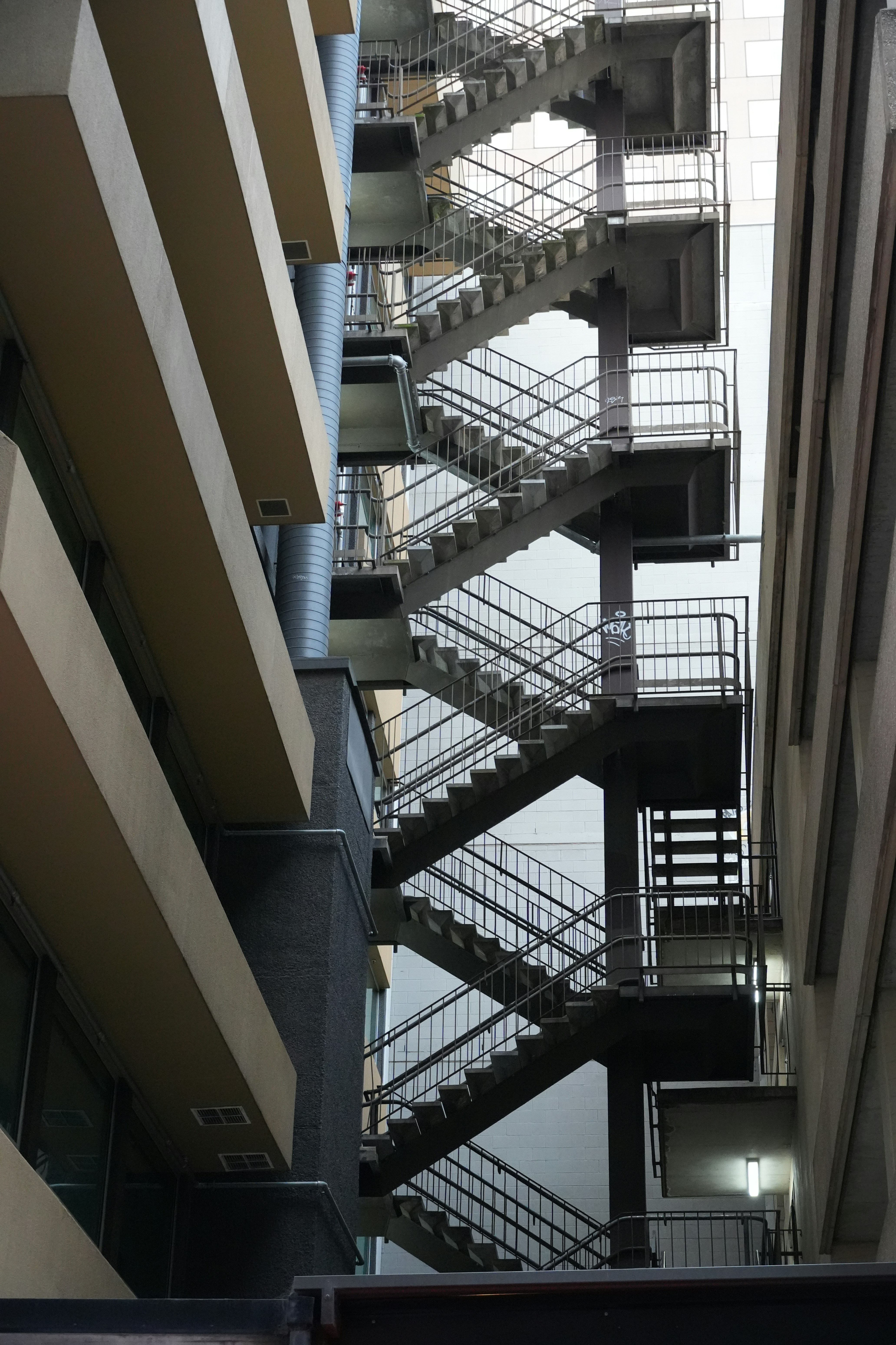 Urban Staircase Tower: A Vertical Crossroad of Fire Escapes