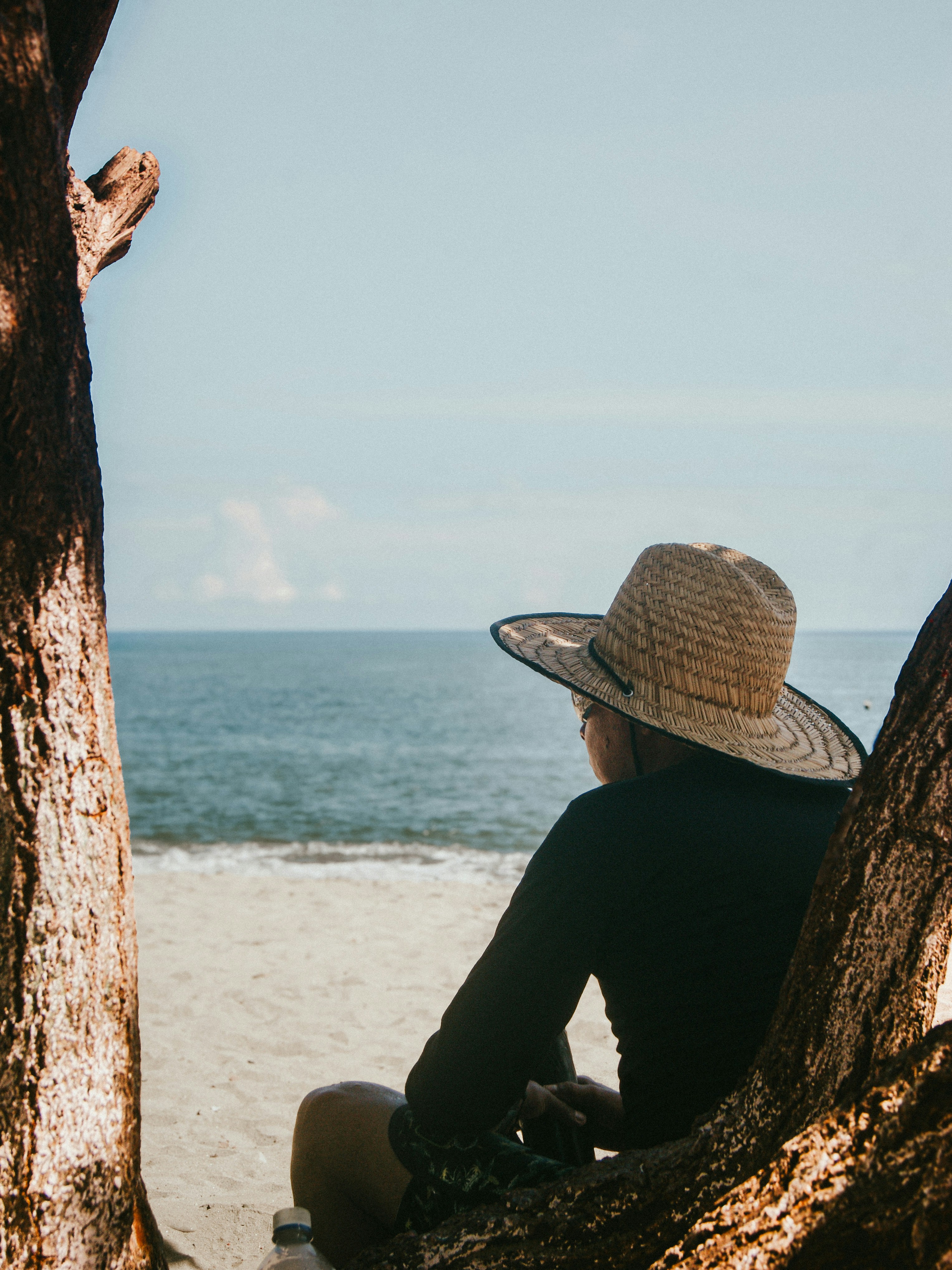 Beachside Reverie: A Sunhat Between Sea and Shade