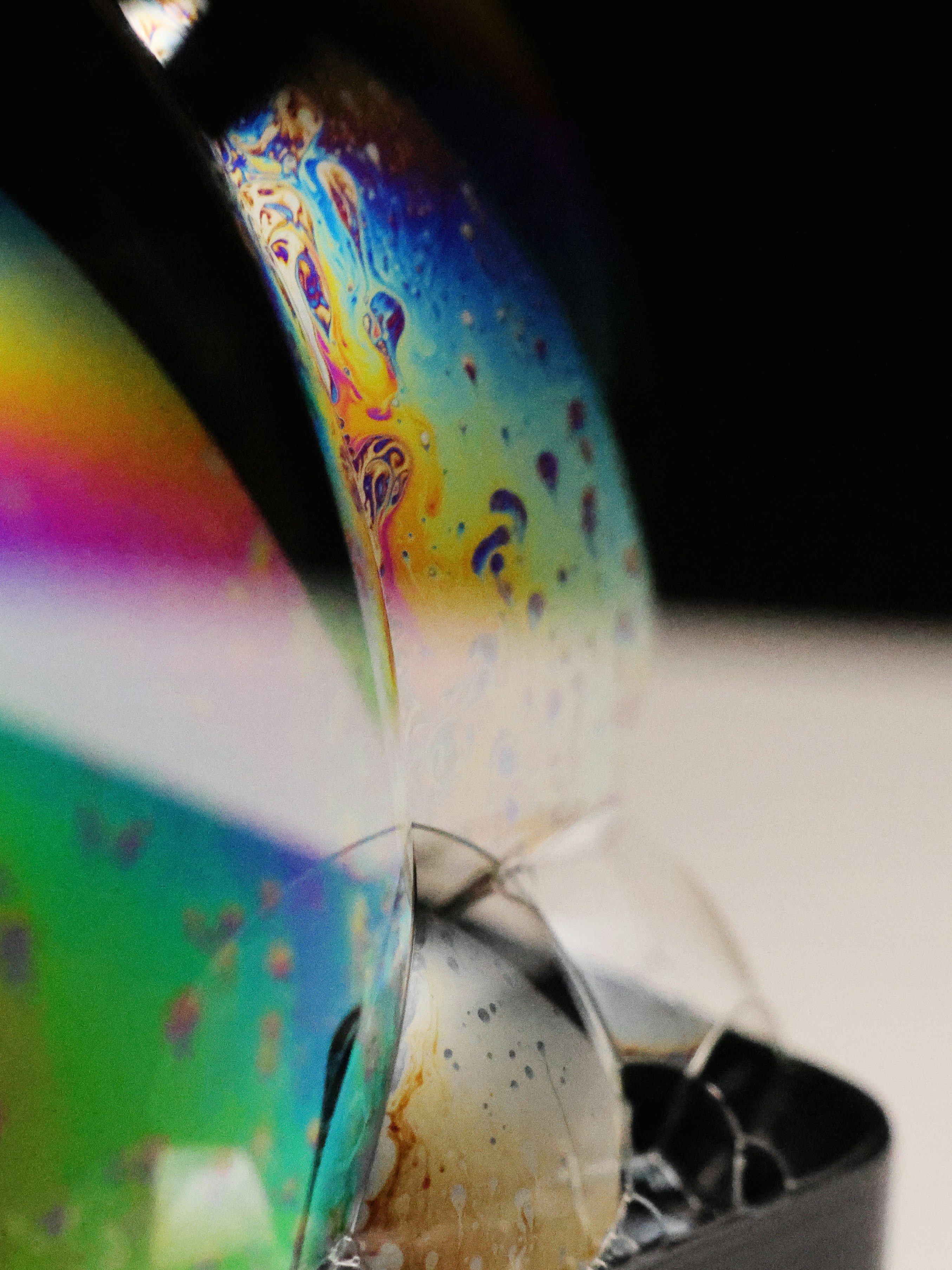 Prismatic Lens: Close-up of a Bursting Bubble Marionette