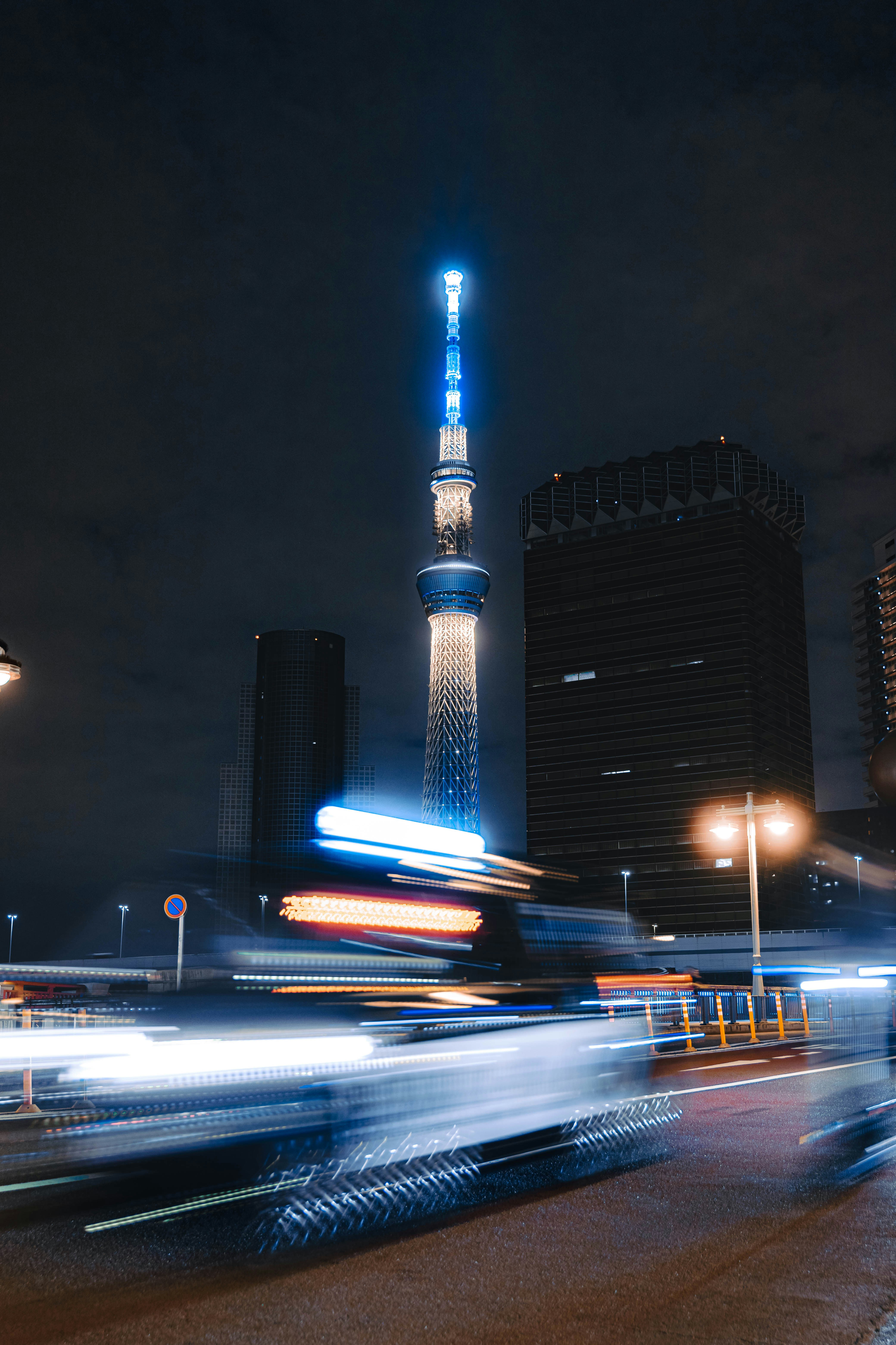 Tokyo Night: Neon Tower Above Blur of Traffic