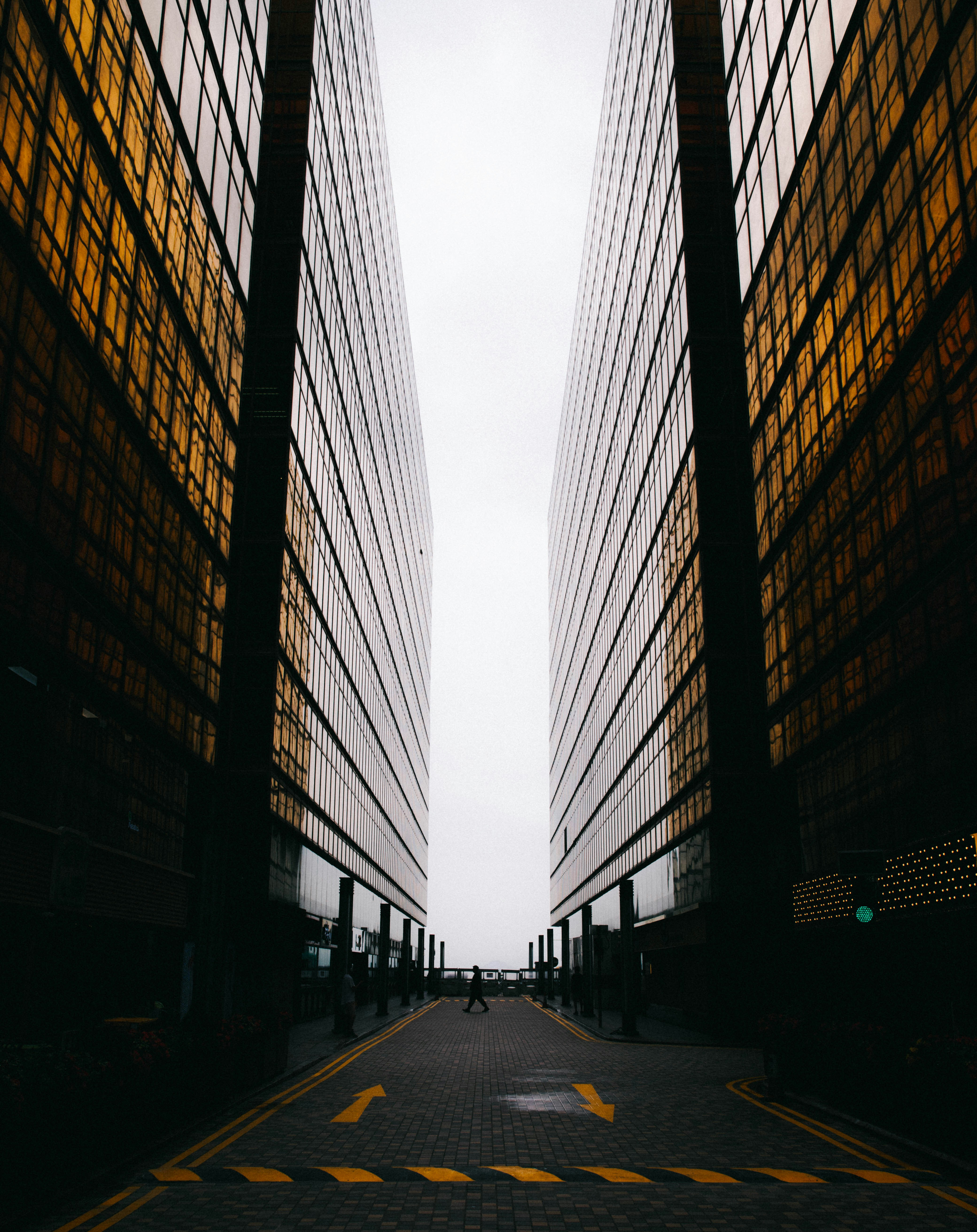 Between Glass Giants: A Vanishing Street Between Skyscraper Reflections