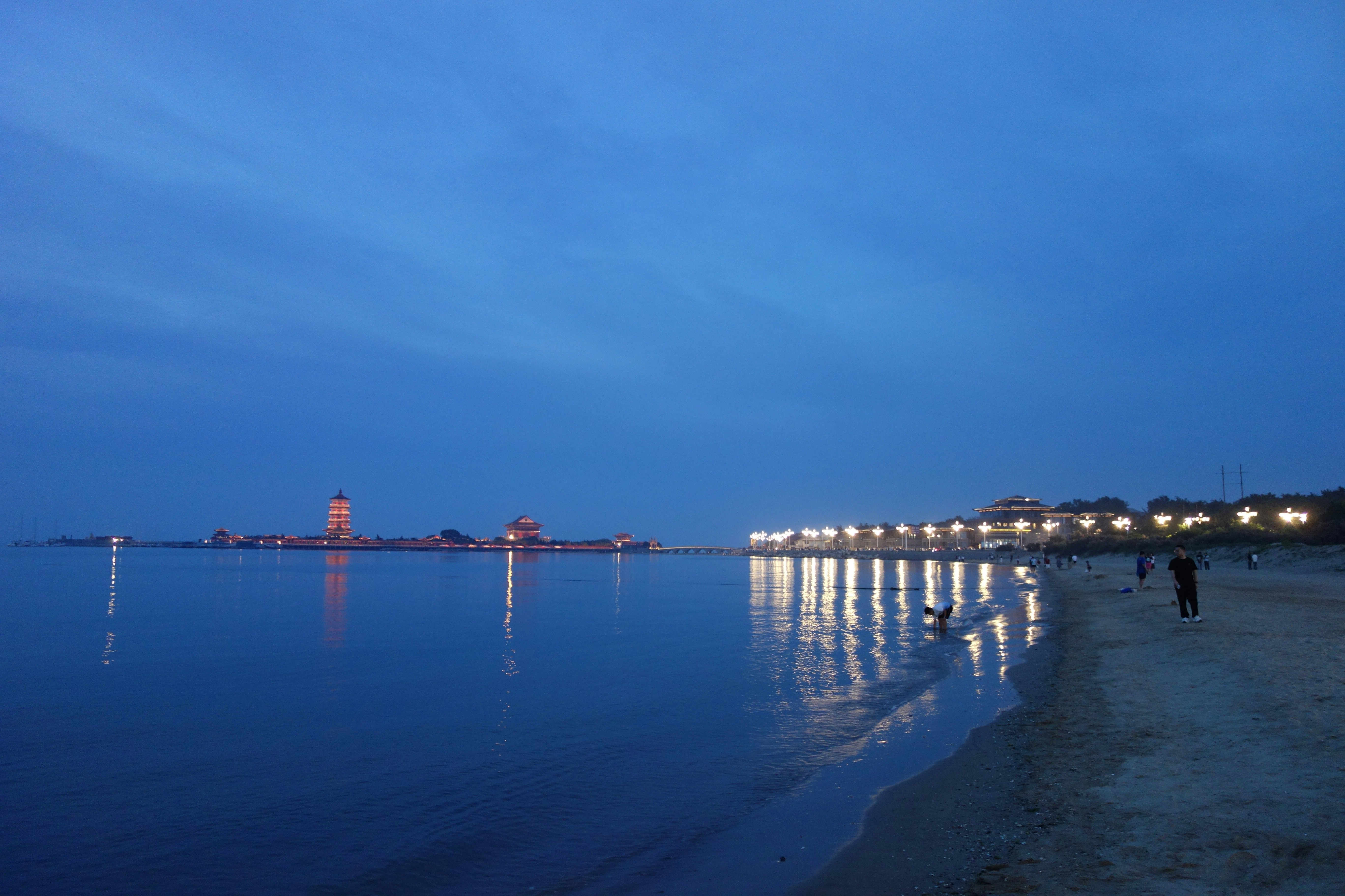Quiet shoreline under a blue hour glow