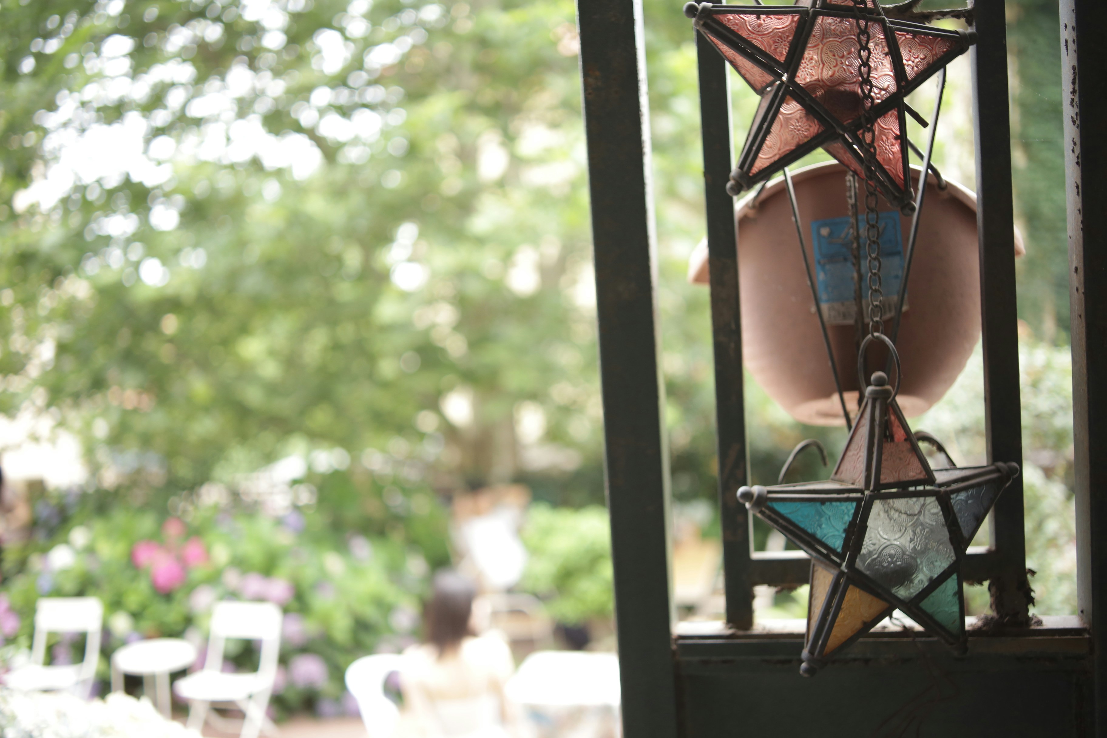 Stained Star Lanterns Framing a Quiet Garden Scene