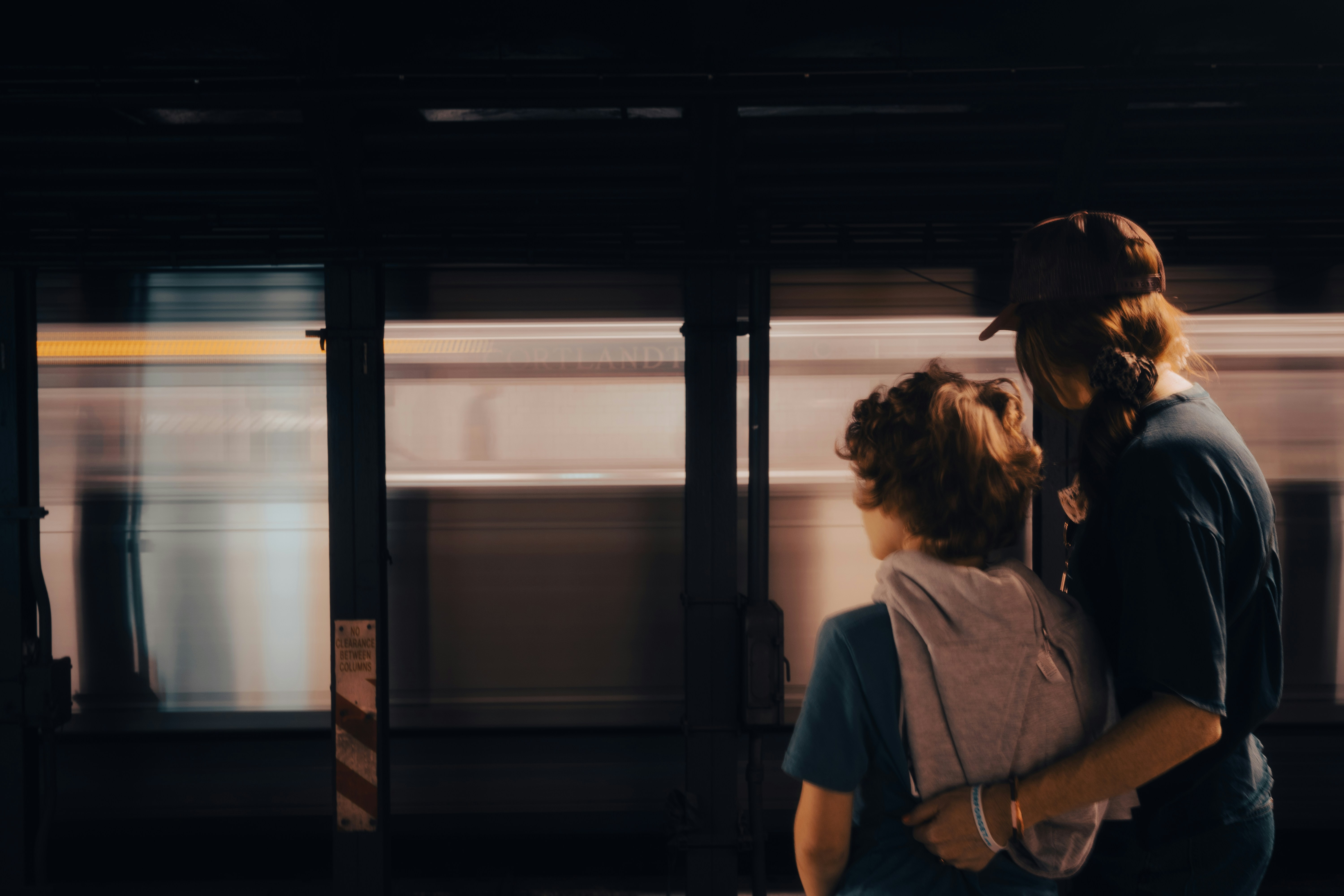 Two Ride the Rail: Shared Moment on a Quiet Platform