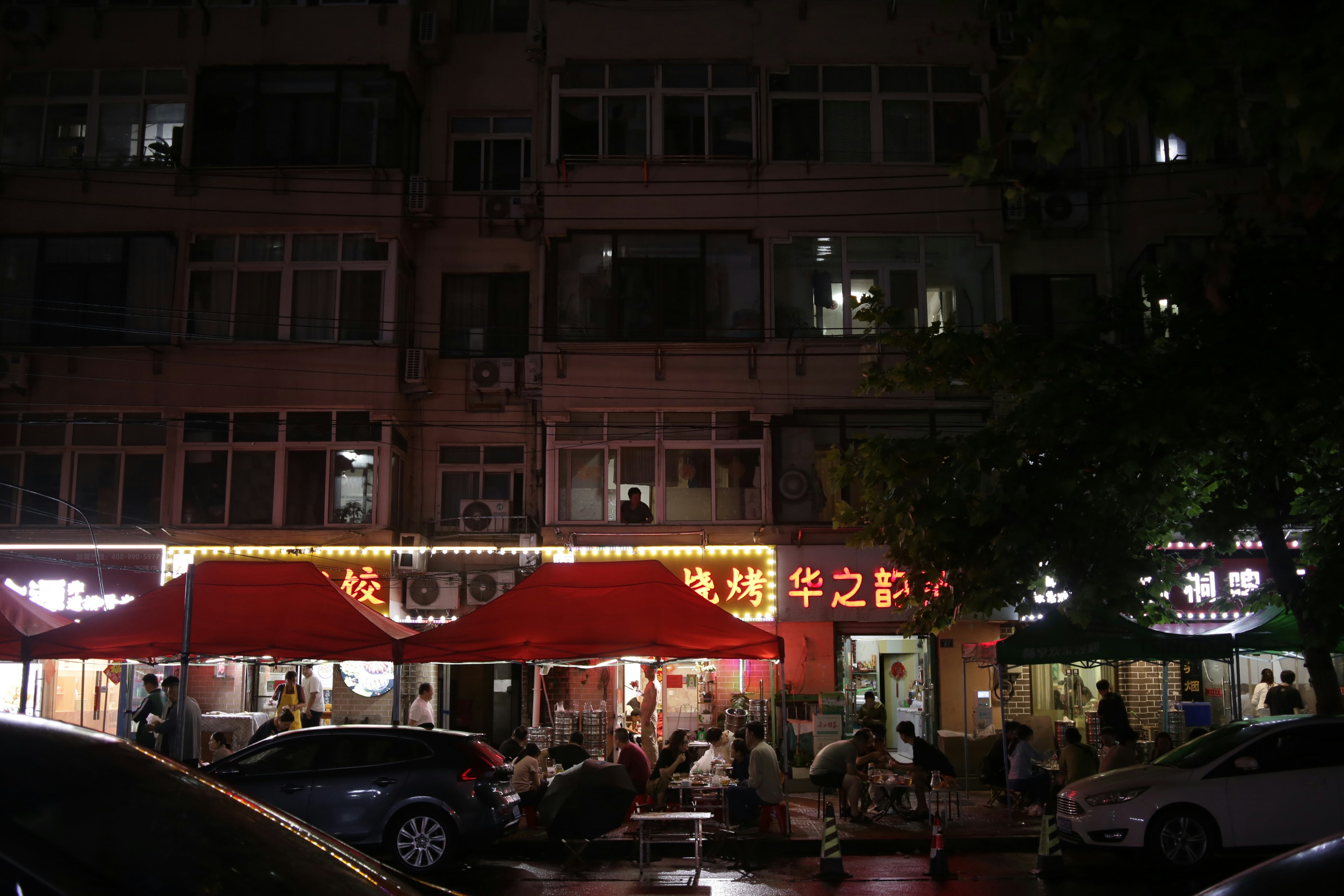 Neon Street Café Amidst Nightlife Reflections