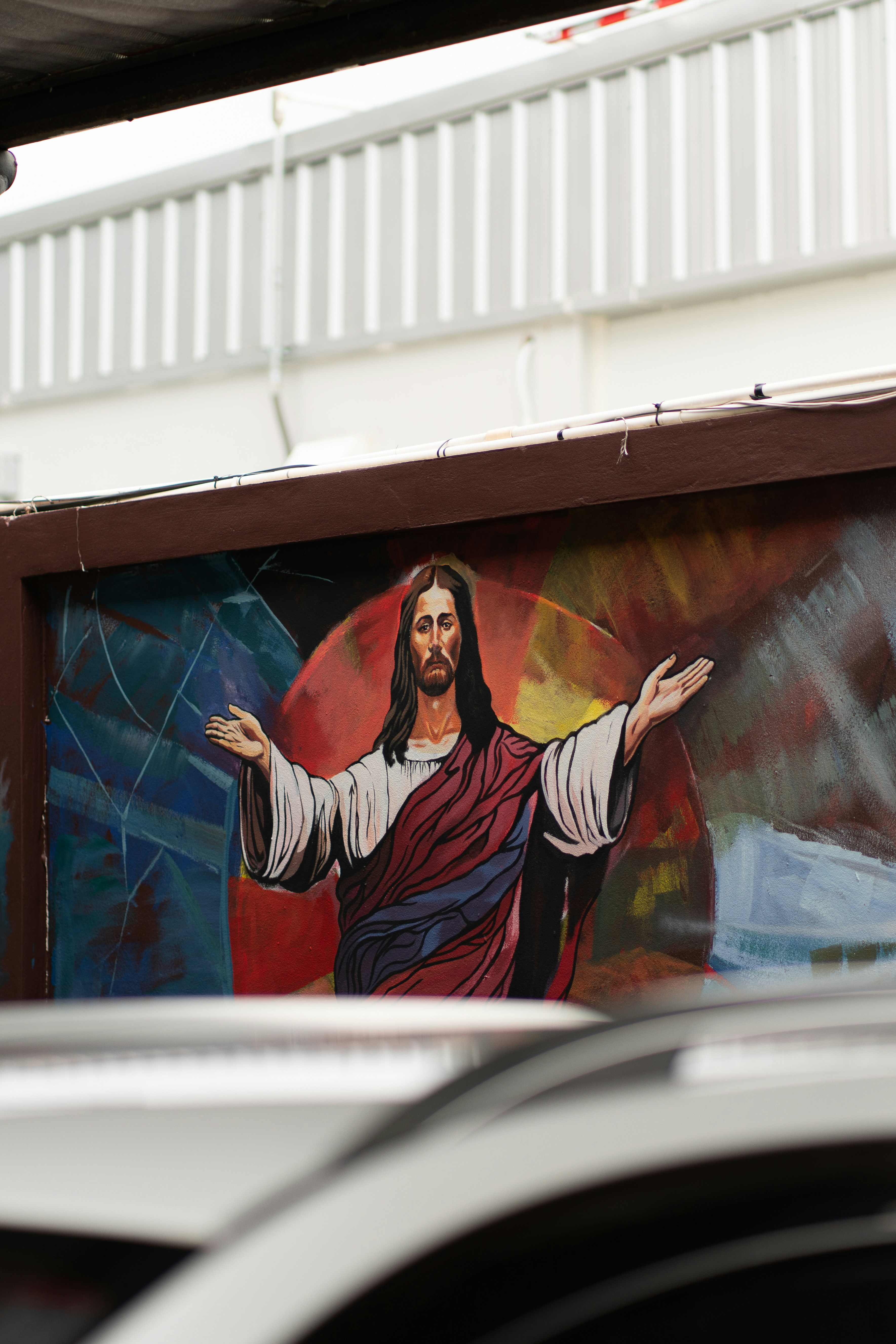 Open-armed Icon in Front of a Painted Backdrop