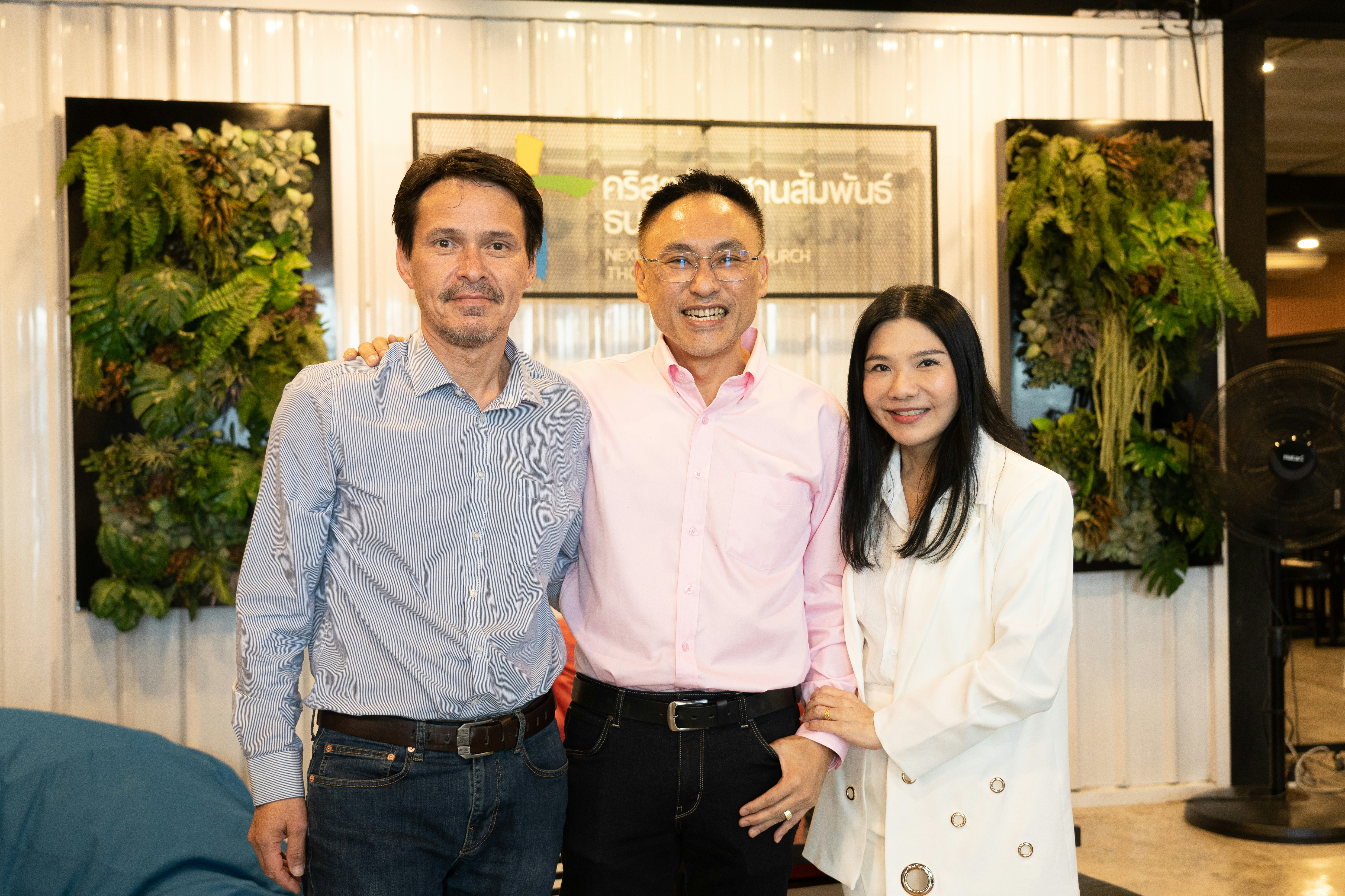 Trios at the Green Wall: Networking Portrait in a Modern Expo Hall
