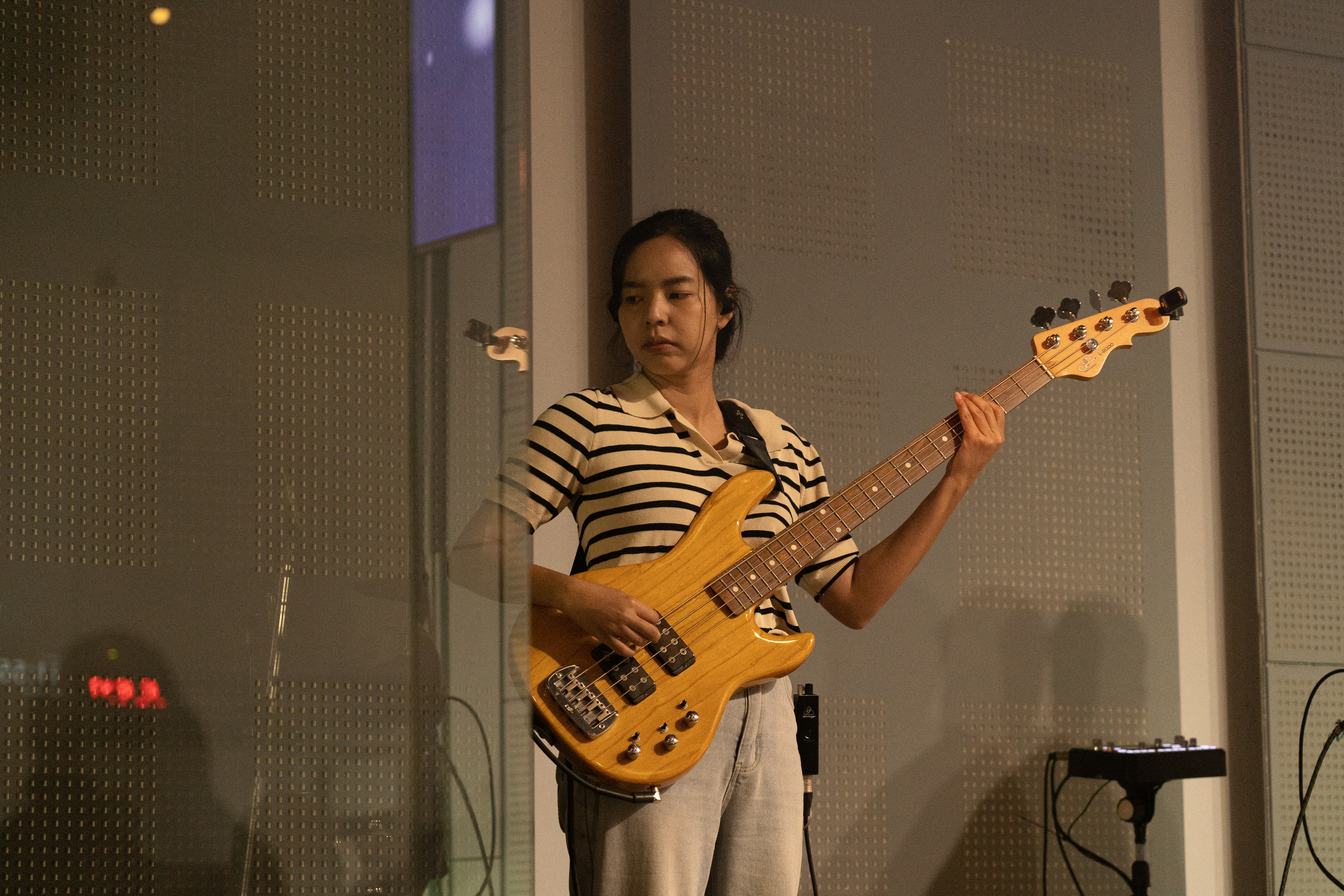 Basslines in Focus: Portrait of a Musician in a Glass Studio