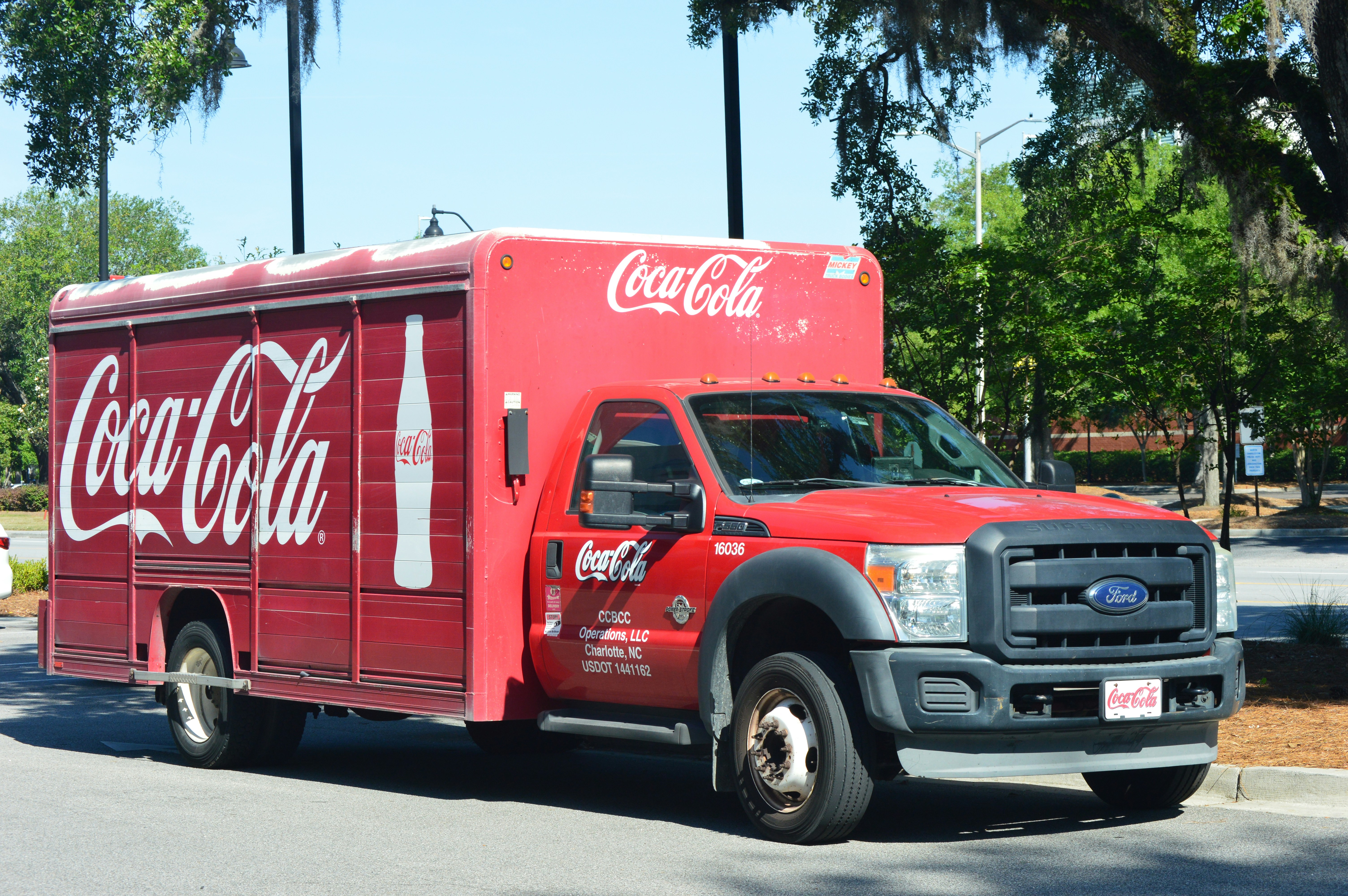 Coca-Cola Delivery Truck: Red Livery and Bold Branding in Parking Lot