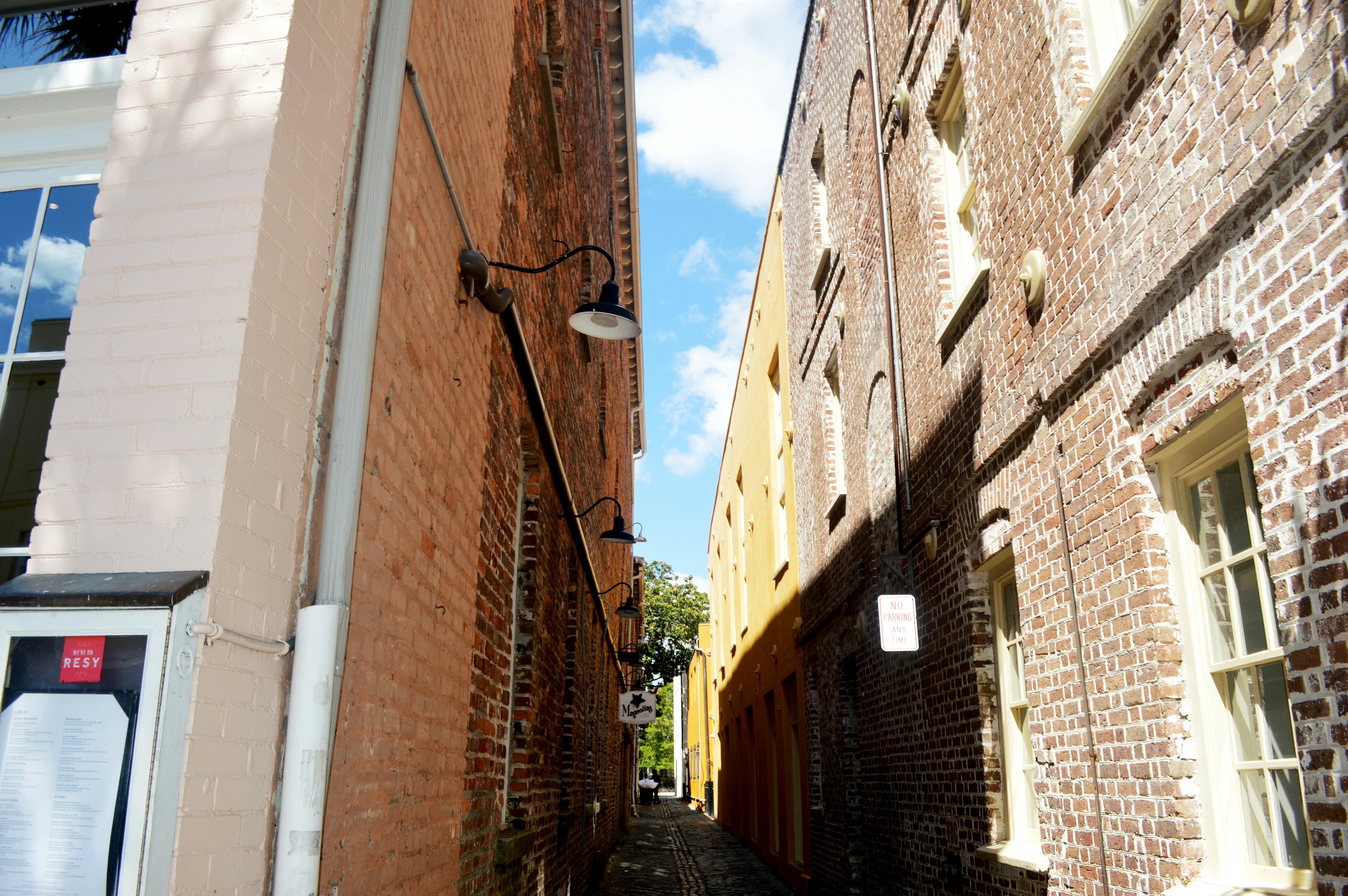 Narrow Brick Alley Converging to Sunlight