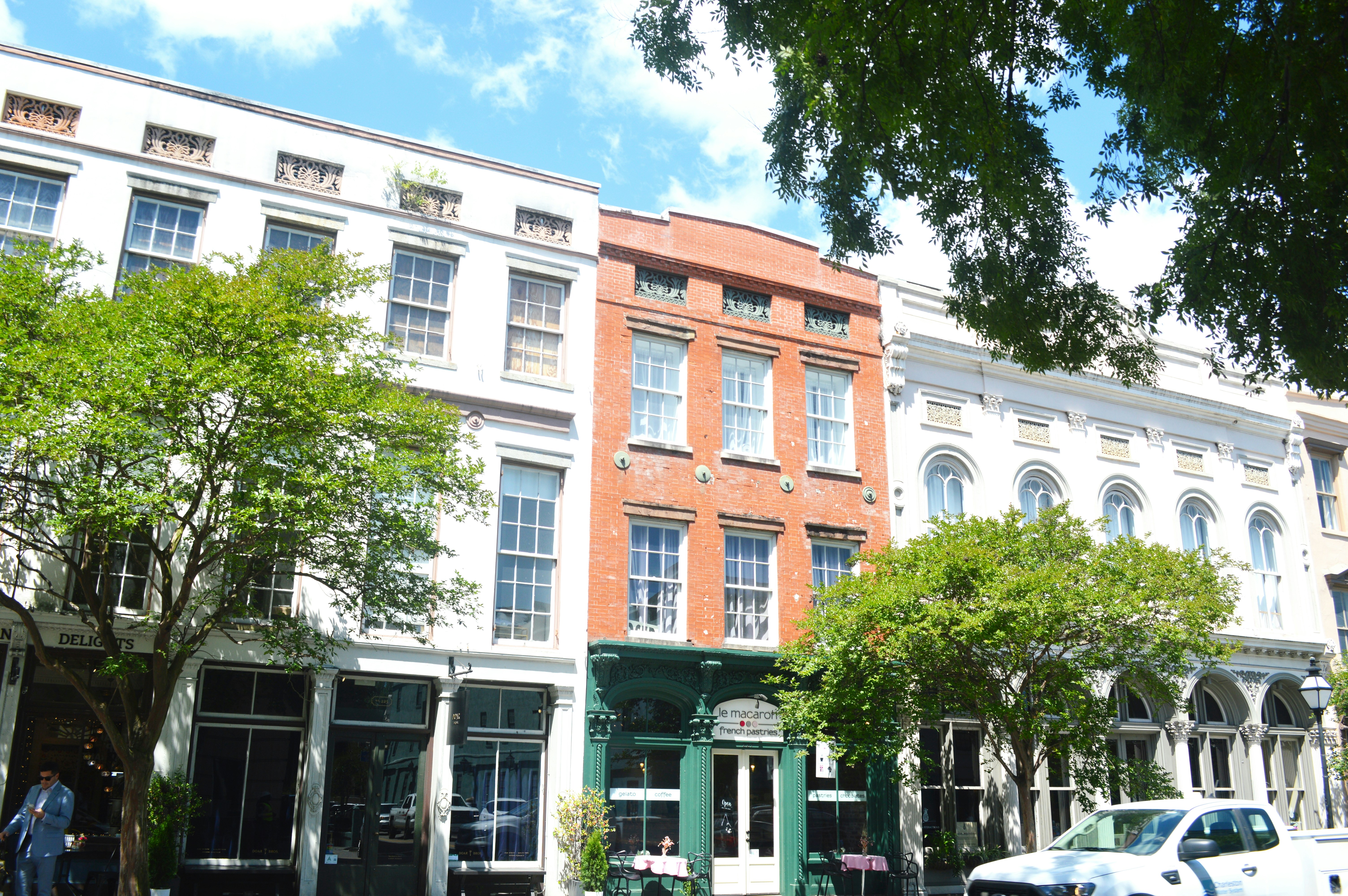 Pastel Rowway: Sunlit Townhouses Under a Canopy of Green