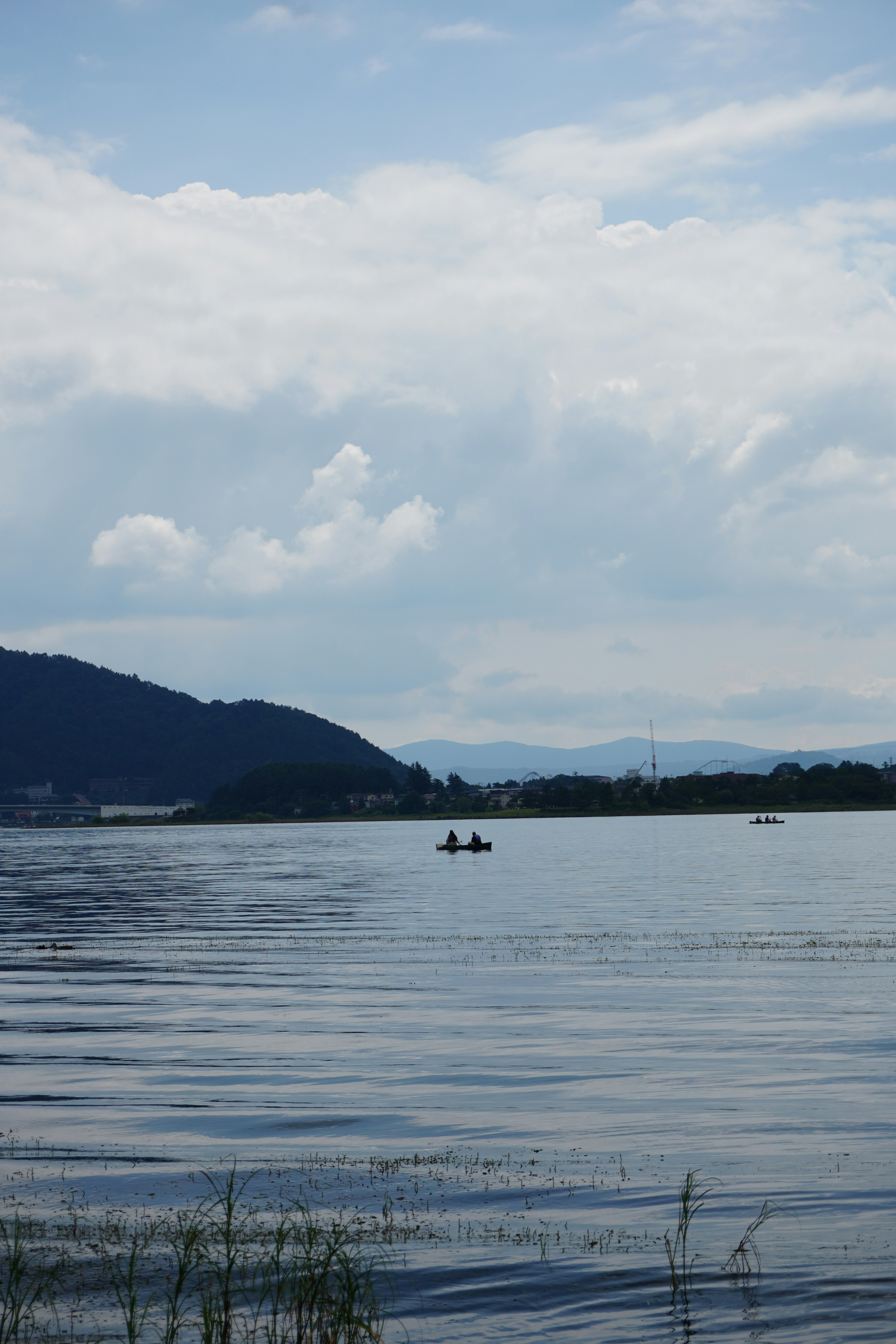 Quiet Boat Parade Across a Distant Lake