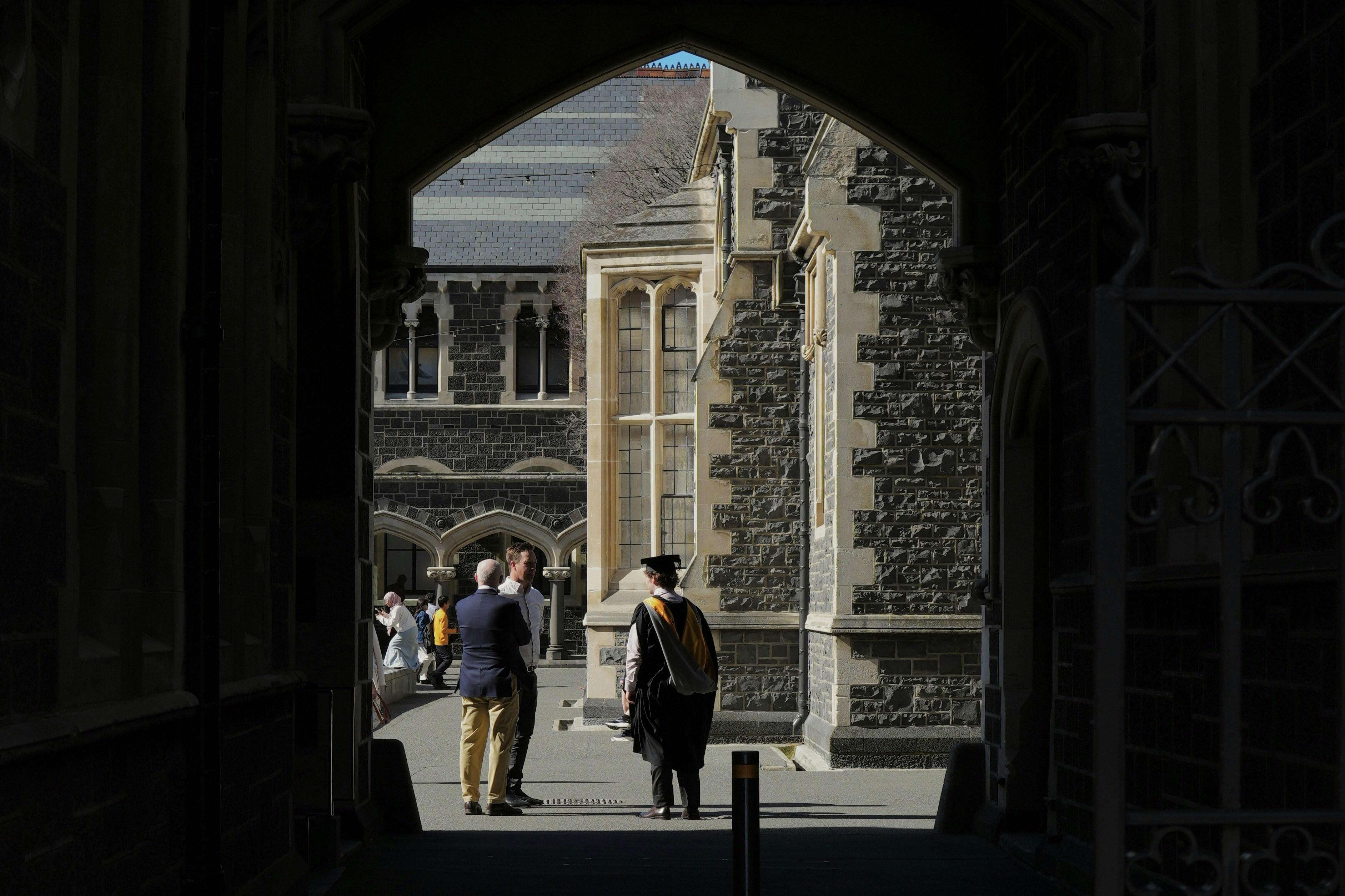 Arched Entrance Framing a Moment in the College Courtyard