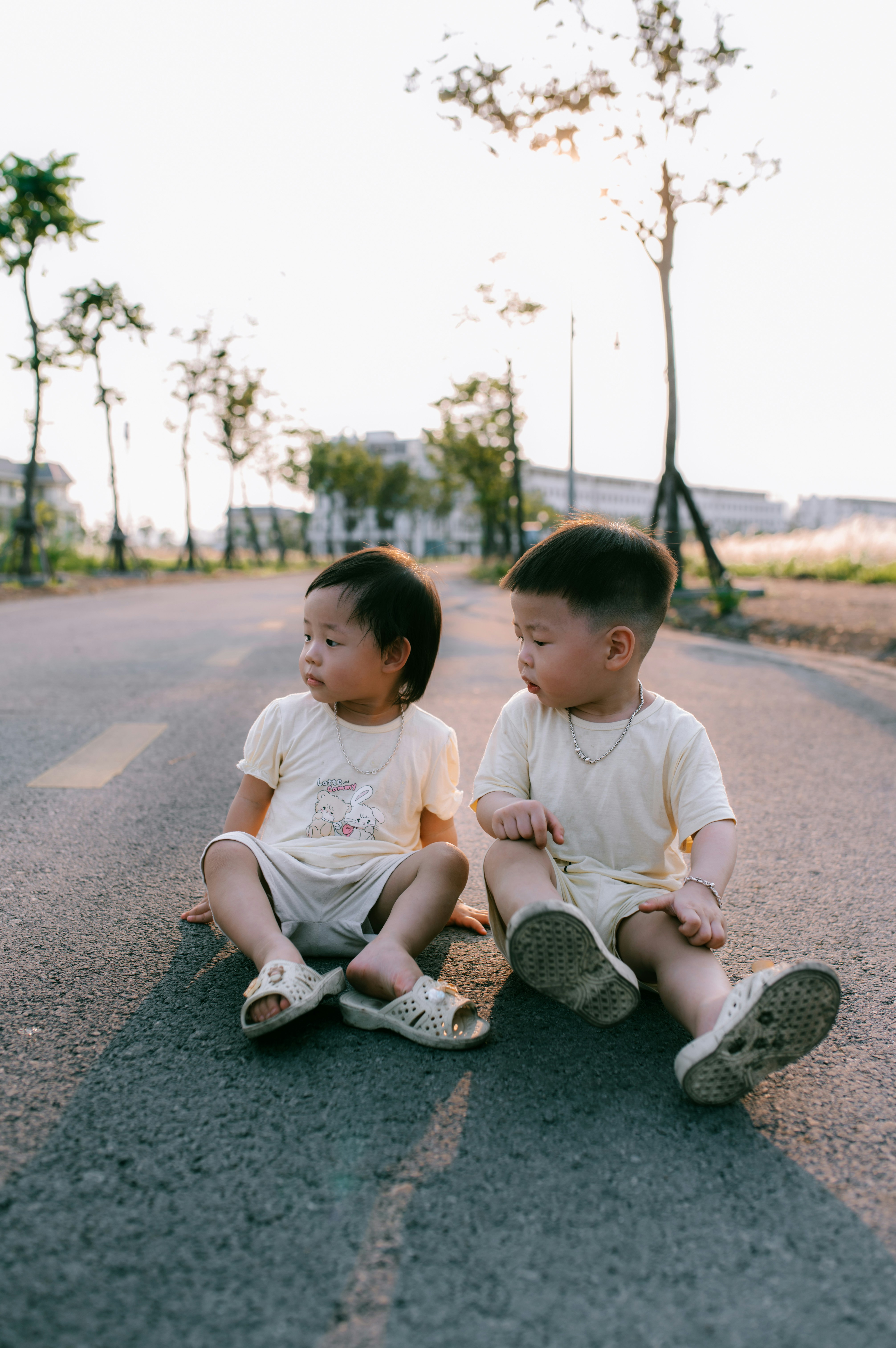 Two Mustard-Toned Souls Sitting Side by Side on a Quiet Path