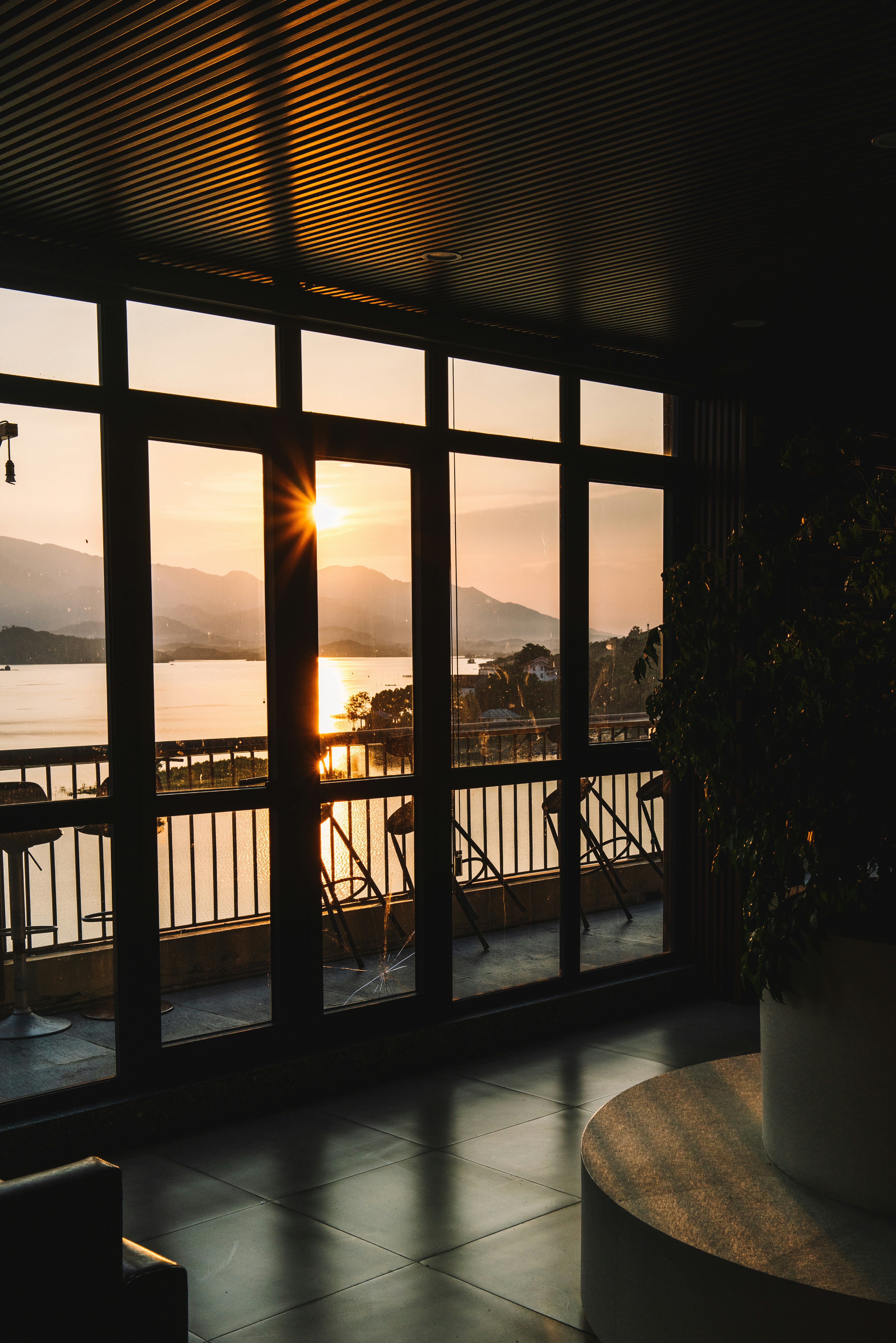 Golden Hour by the Glass: Sunset Over the Balcony