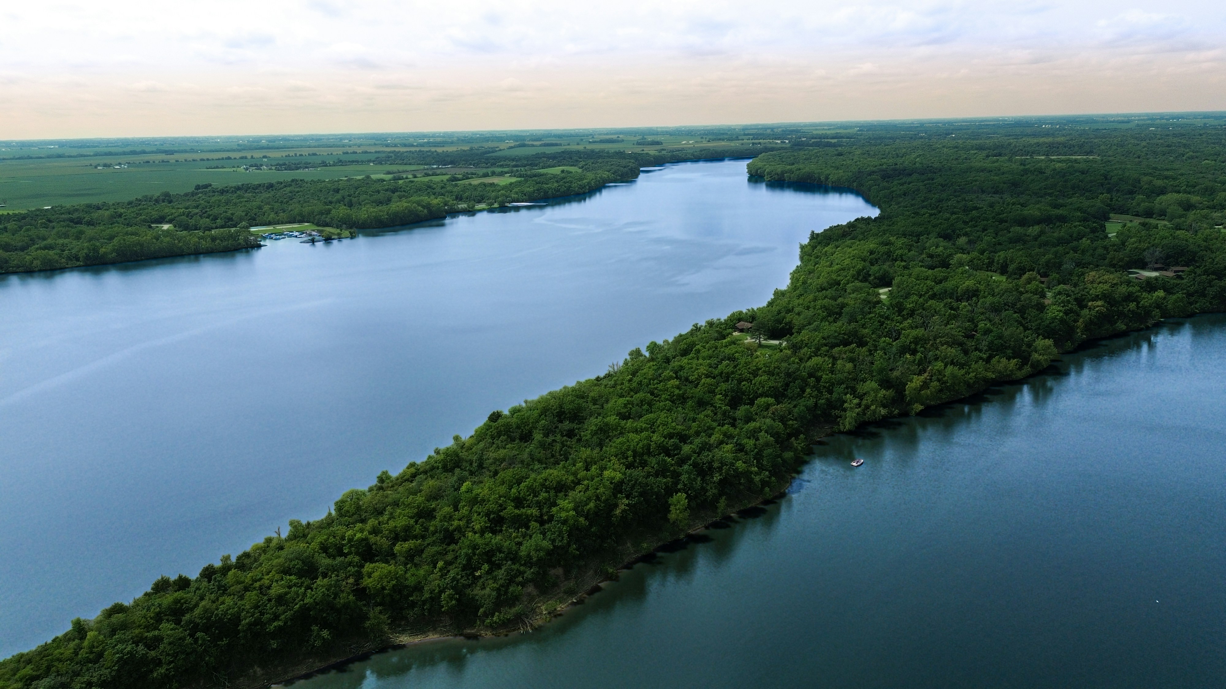 Verdant River Loop: Aerial Wake Between Forested Ribbons