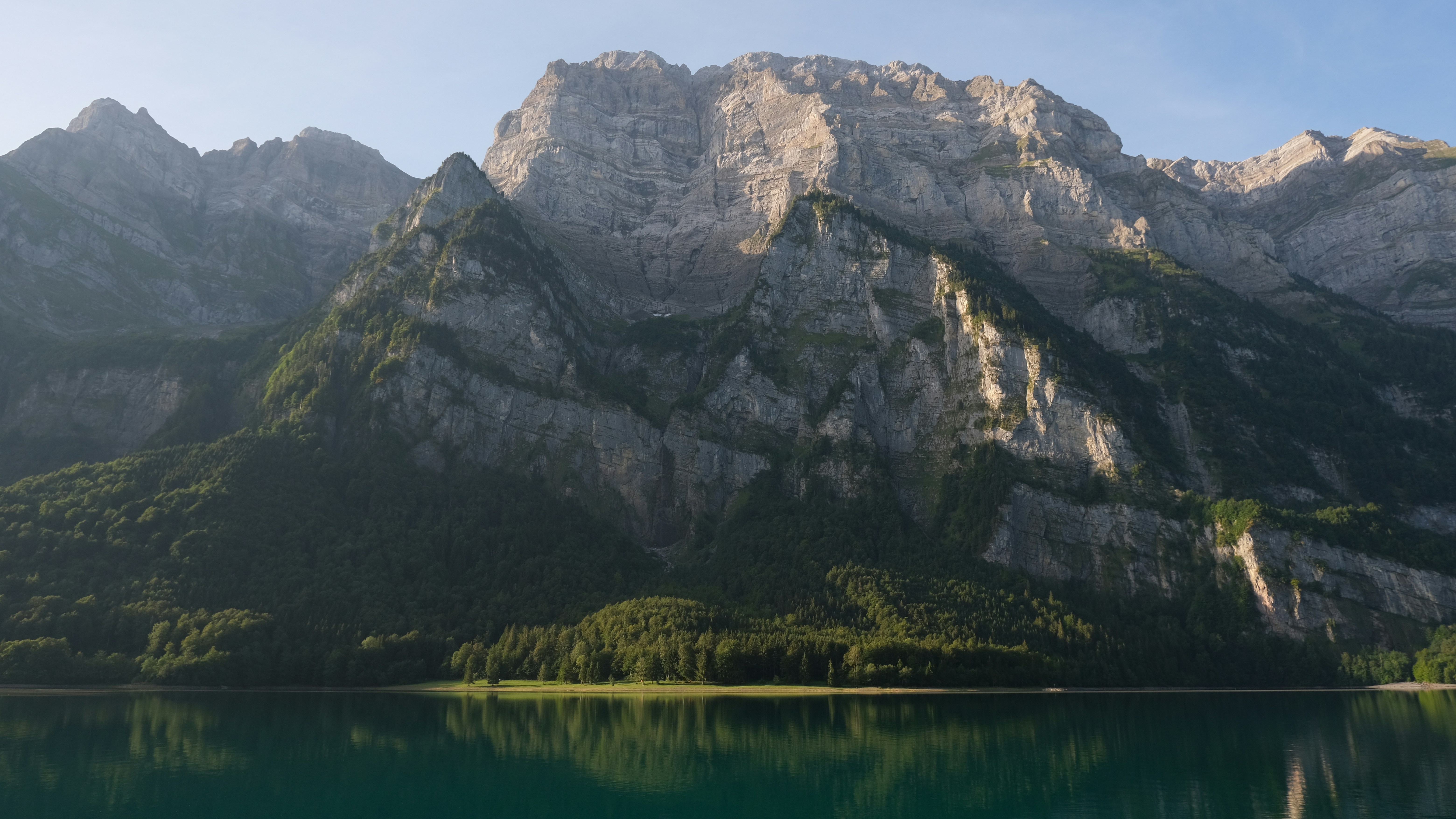 Mirror of Peaks: Lakefront Amidst Alpine Cliffs