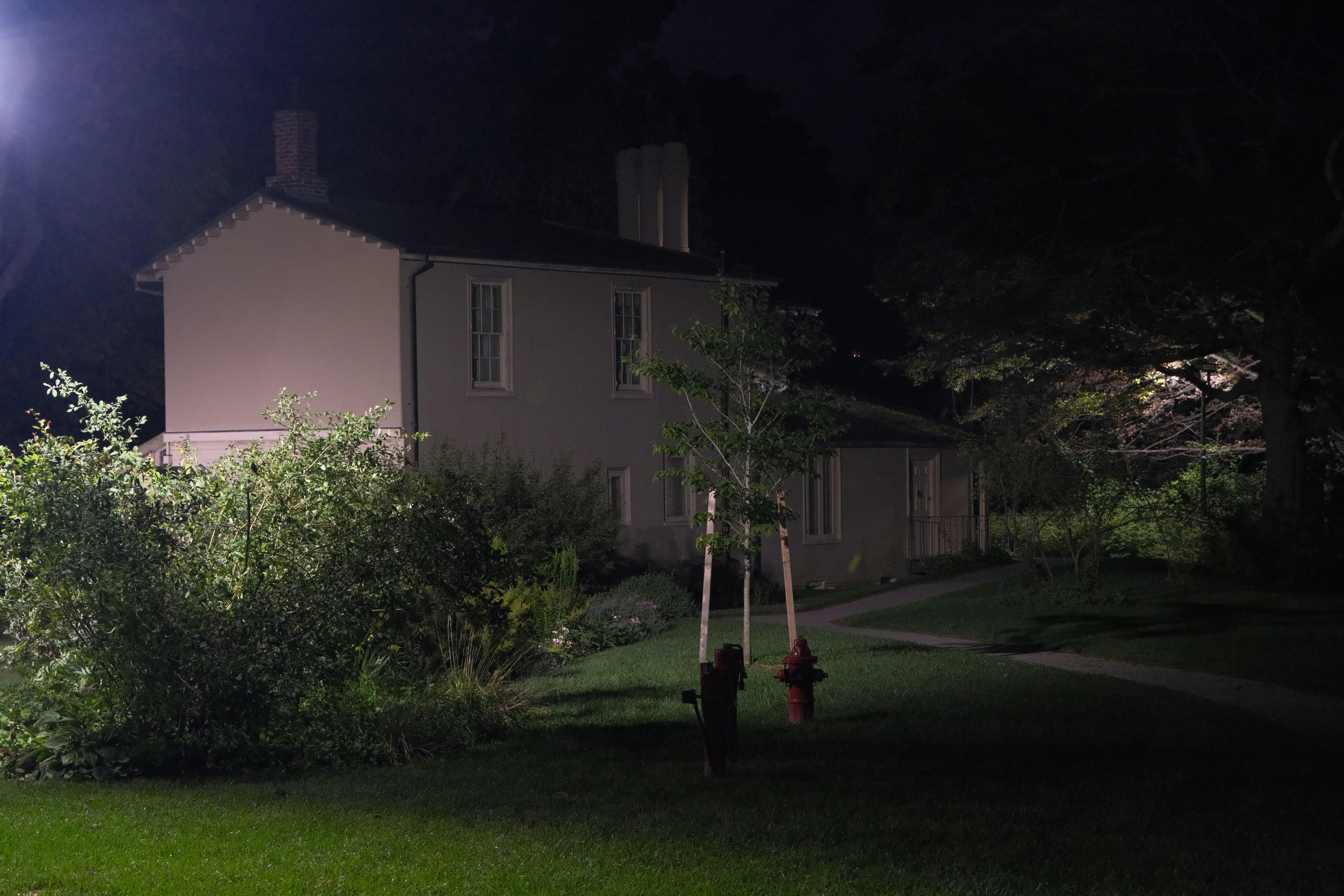 Nighttime suburban glow: a quiet house under a soft halo of light
