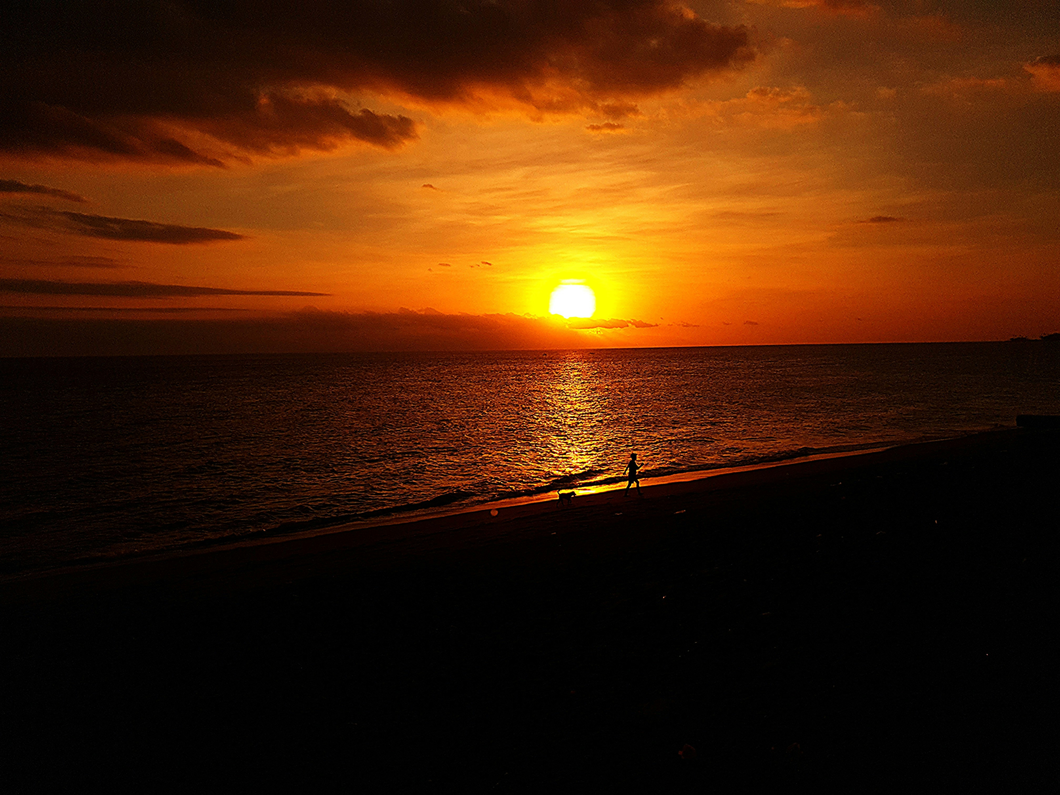 Sundown Silhouette Over Quiet Shore