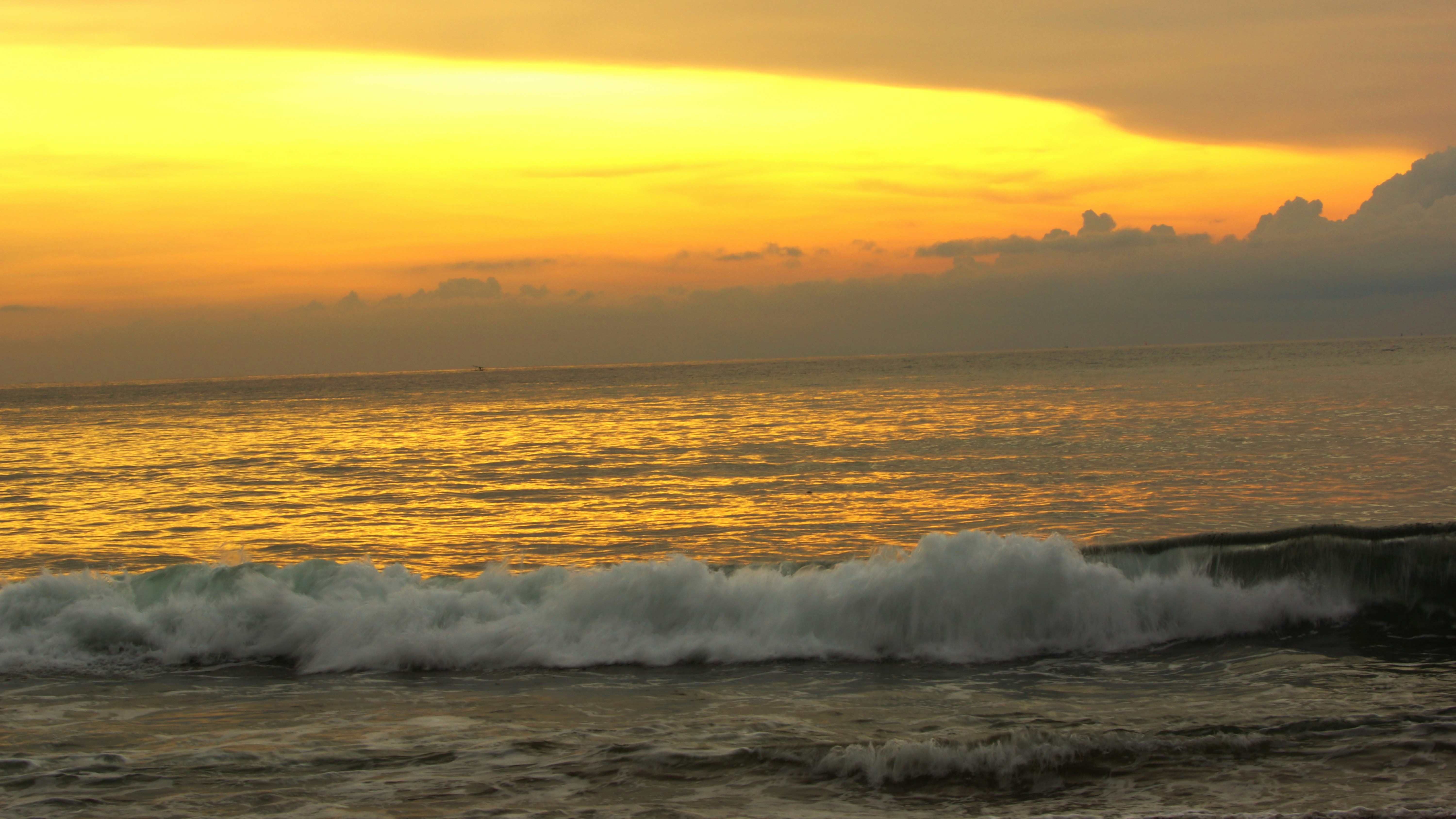 Golden Crest: Waves at Sunset over a Quiet Sea