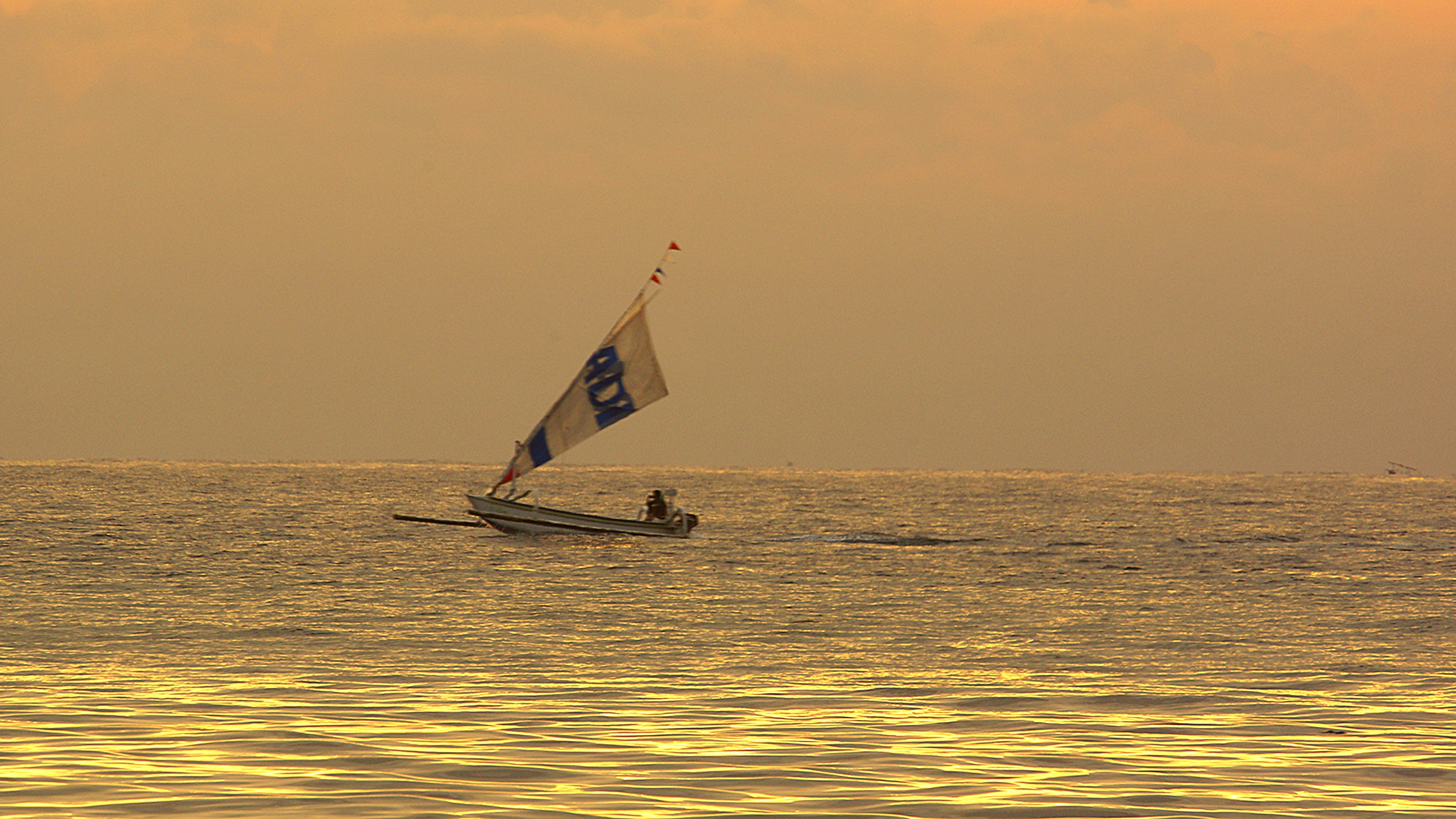 Quiet Horizon: A lone windrider on amber seas