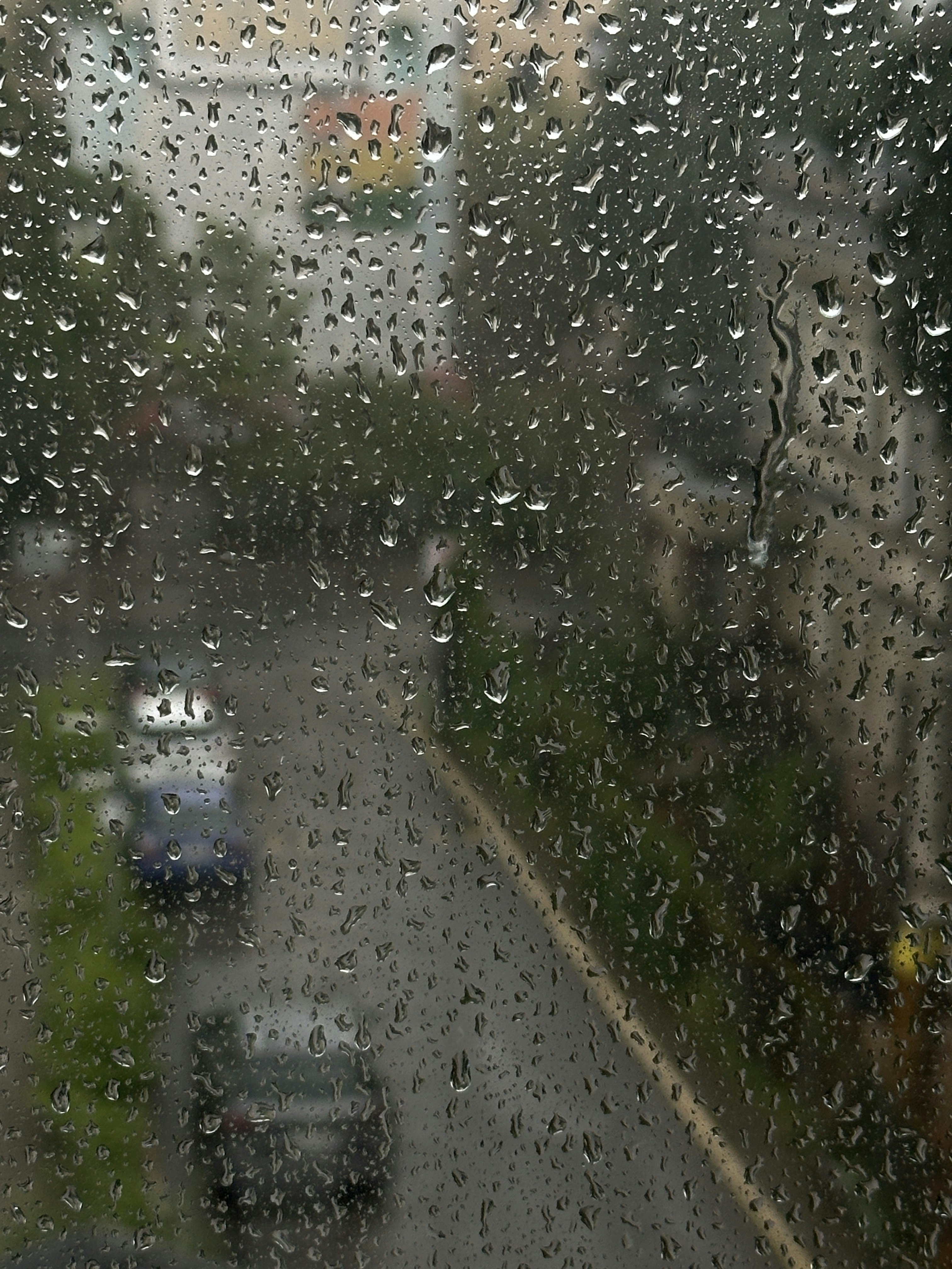 Rain-Streaked Window Over a Quiet Street