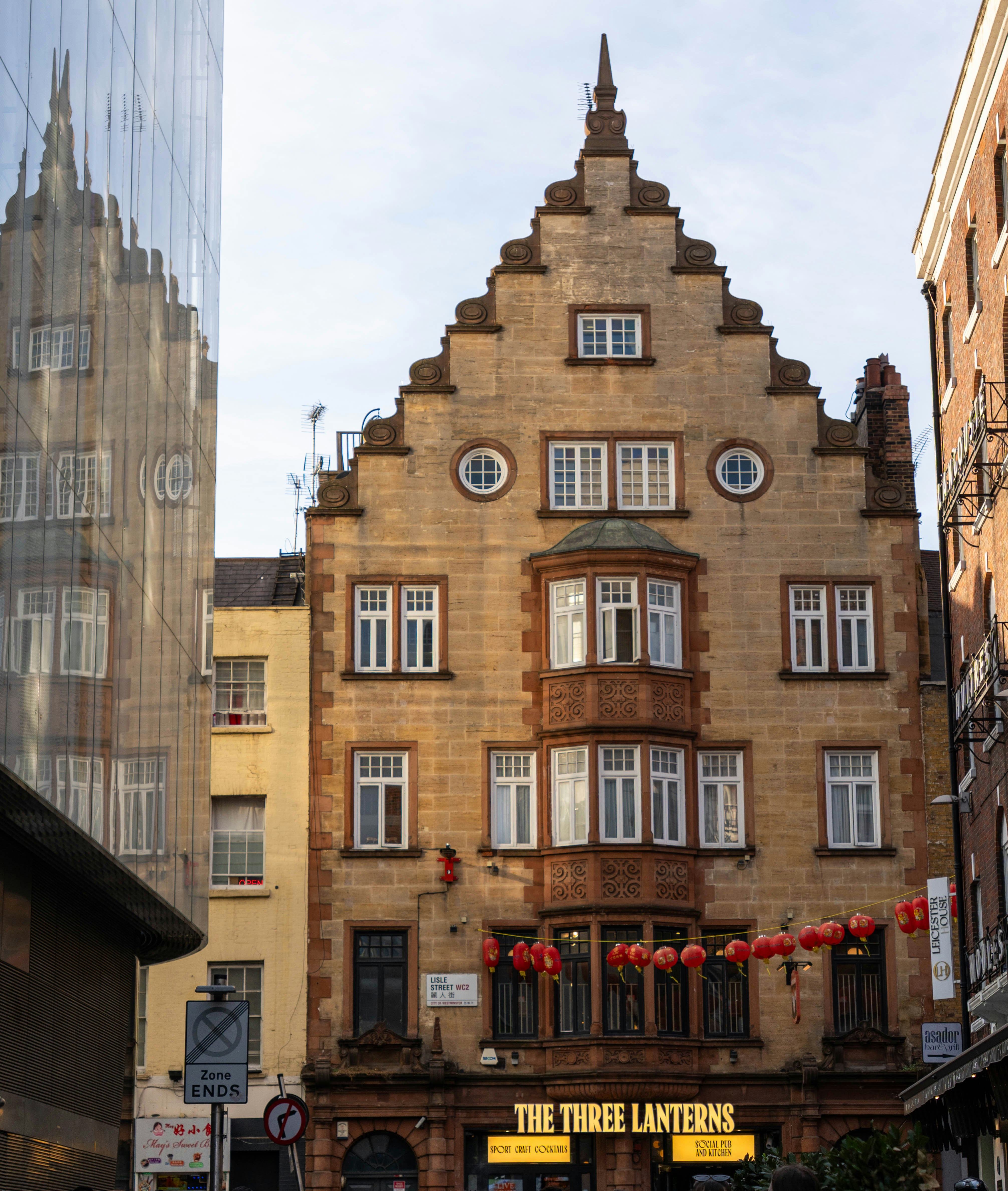 A Stately Facade Between Modern Glass and Red Lanterns