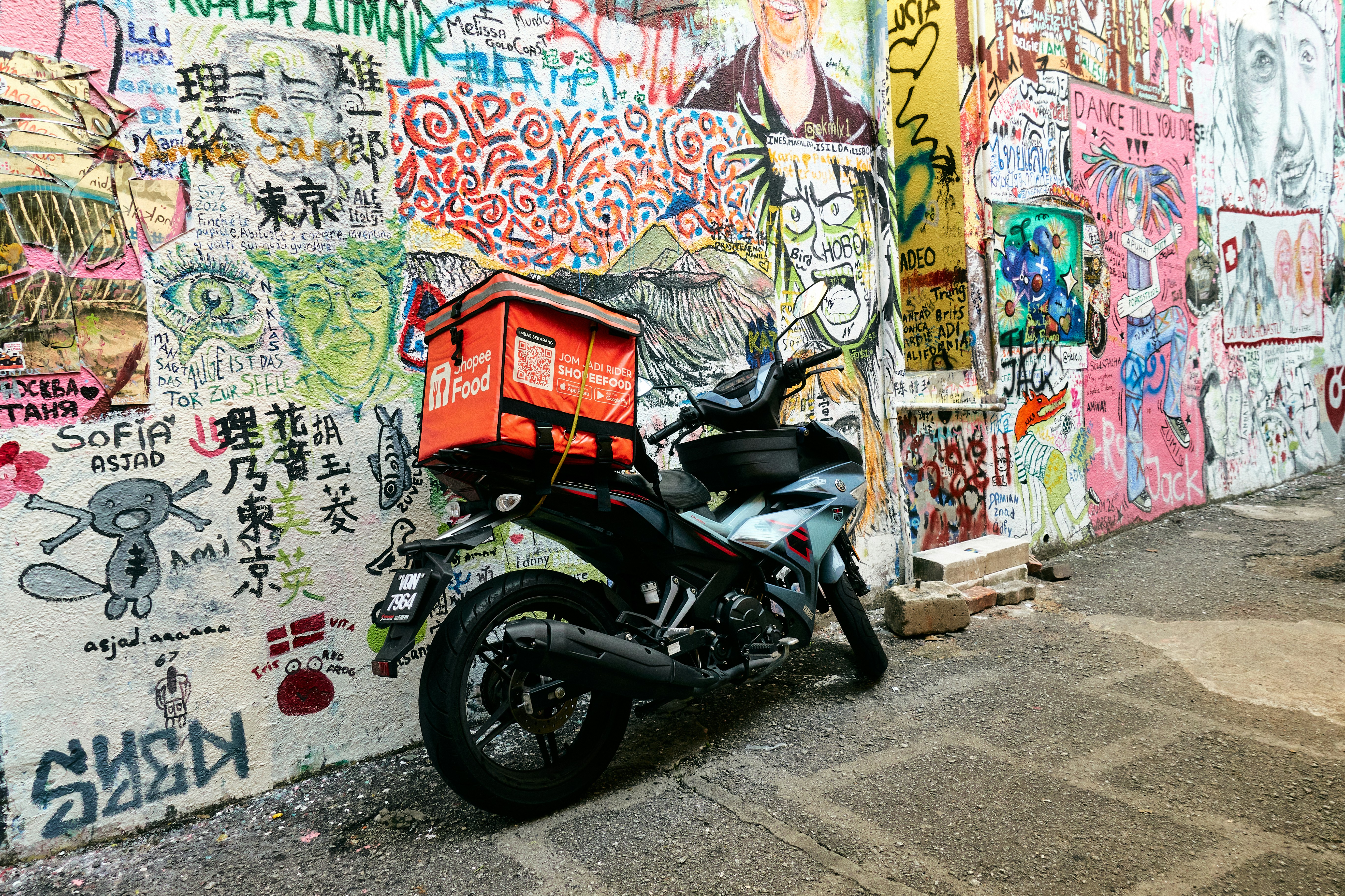 Graffiti Alleybound: A Delivery Bike Resting Among Colorful Walls