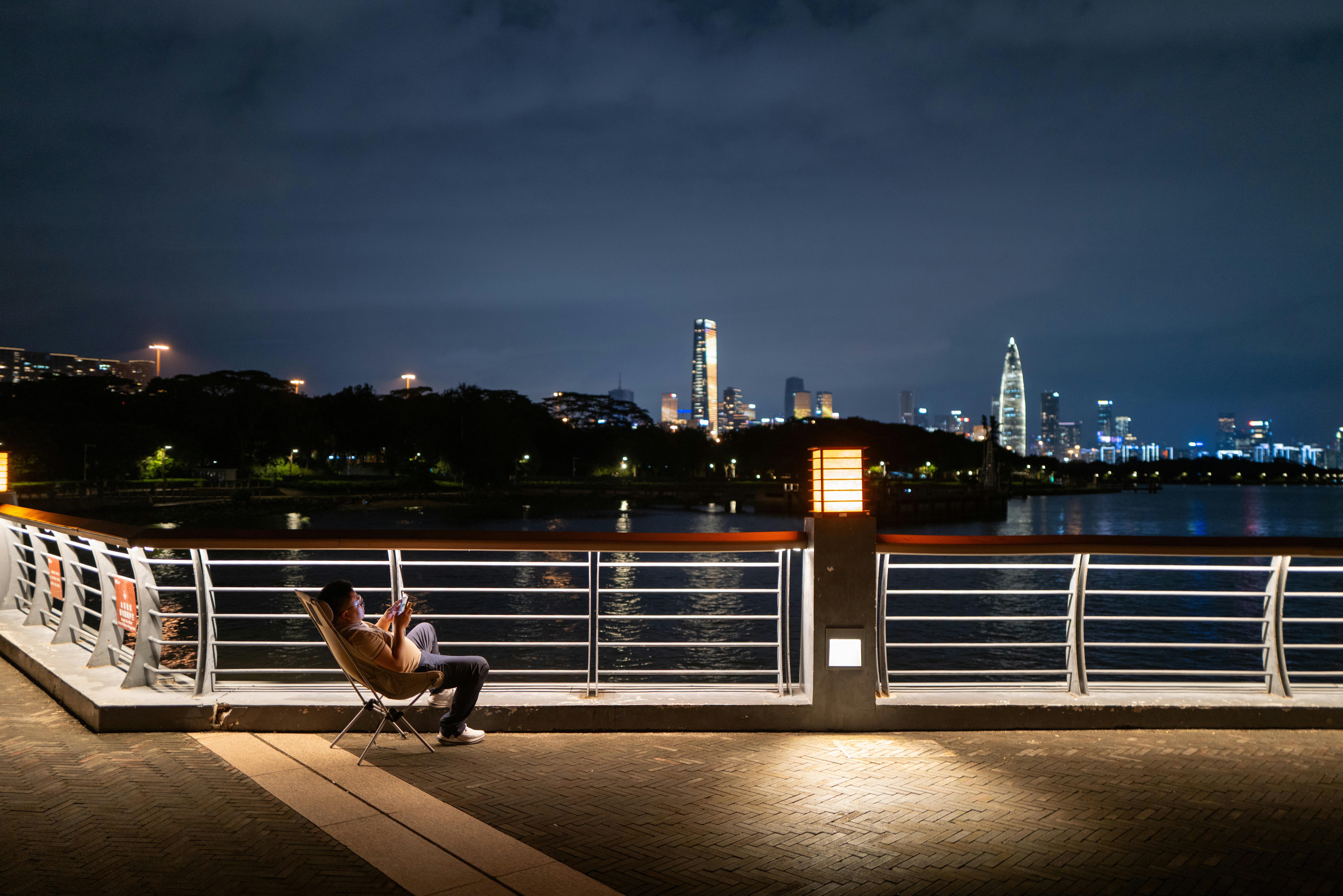 Night Breeze on the Riverwalk: A Moment of Quiet by the City Lights