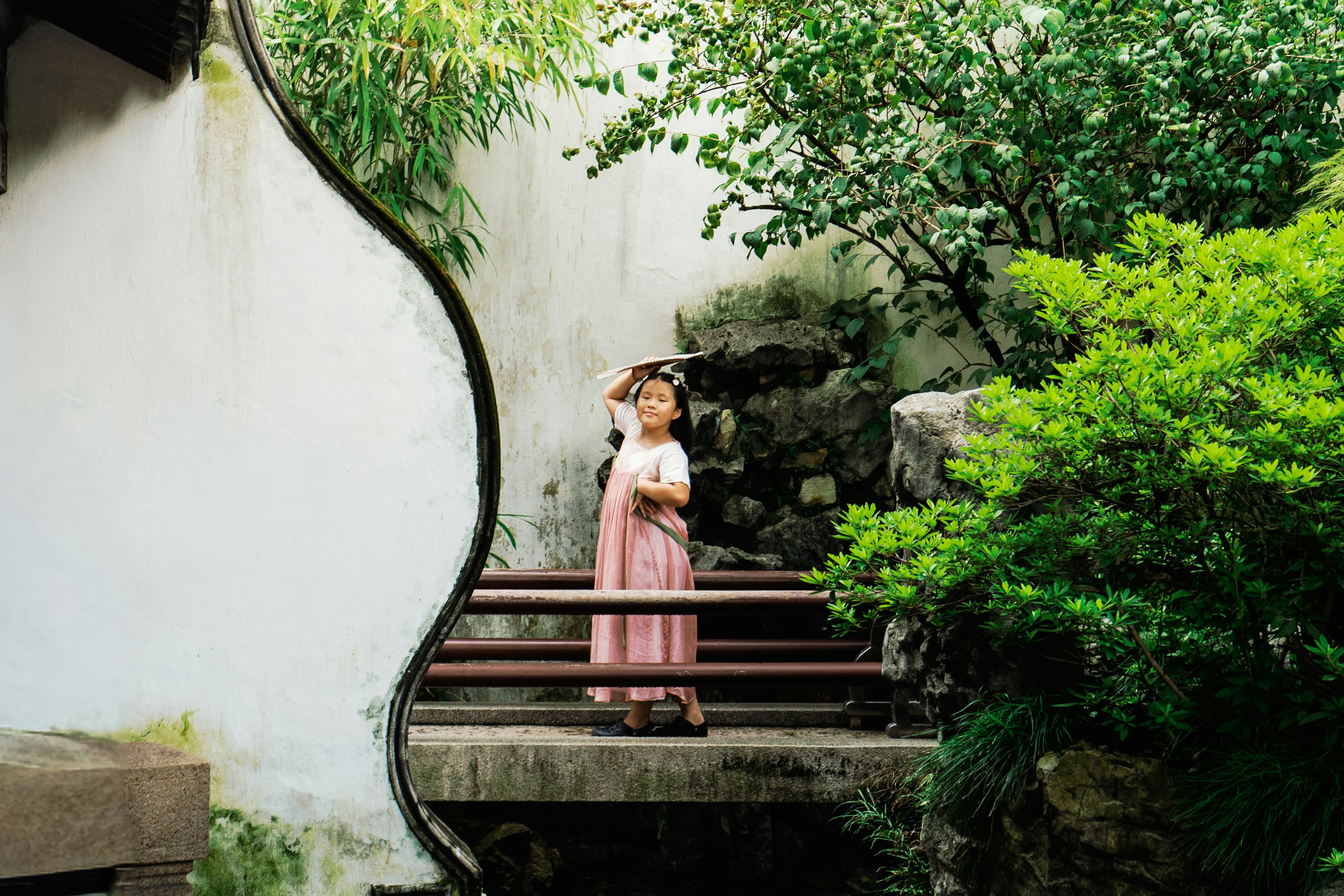 Girl in Pink Dress on a Serpentine Wall