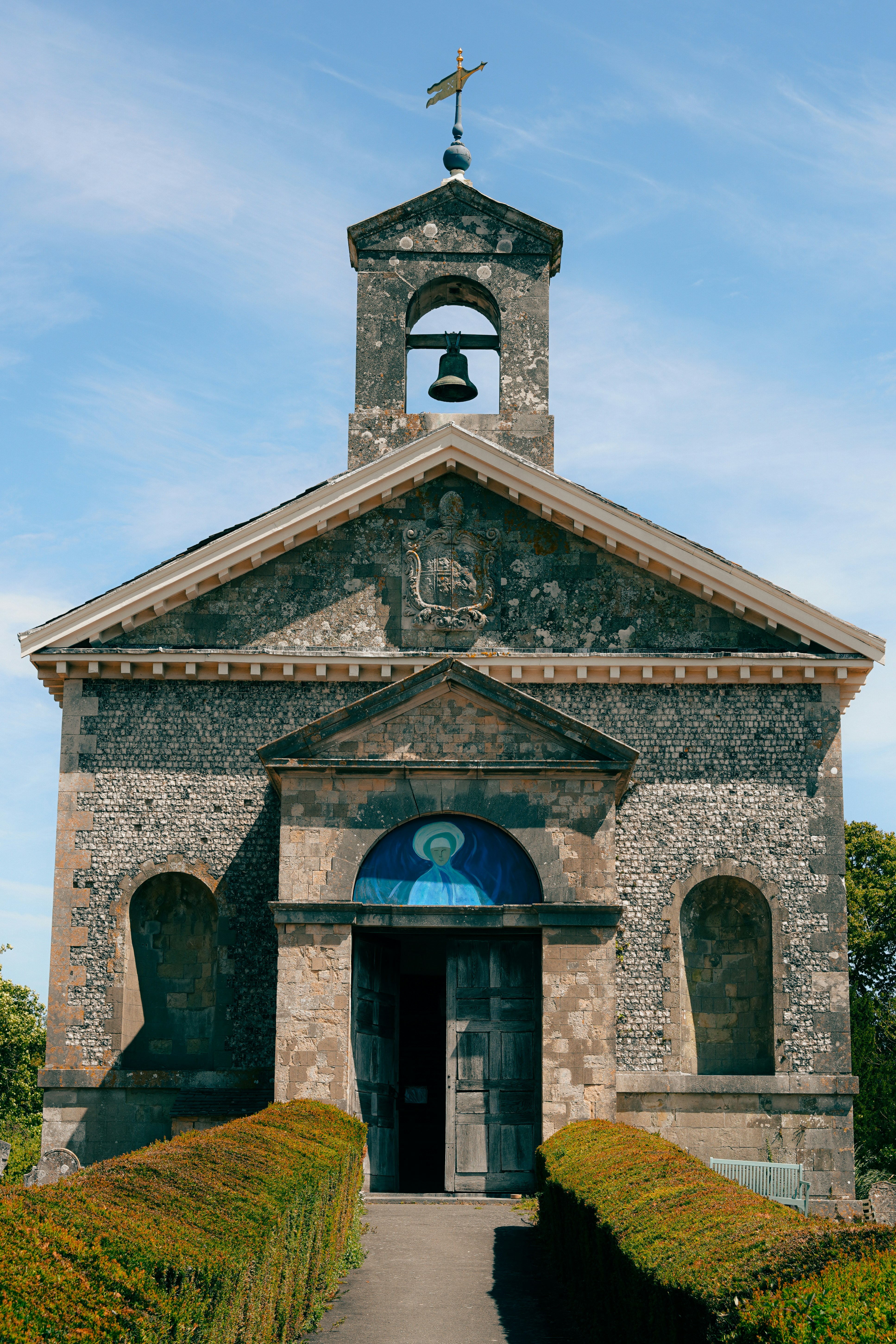 Old Chapel with Central Portal under Blue Sky