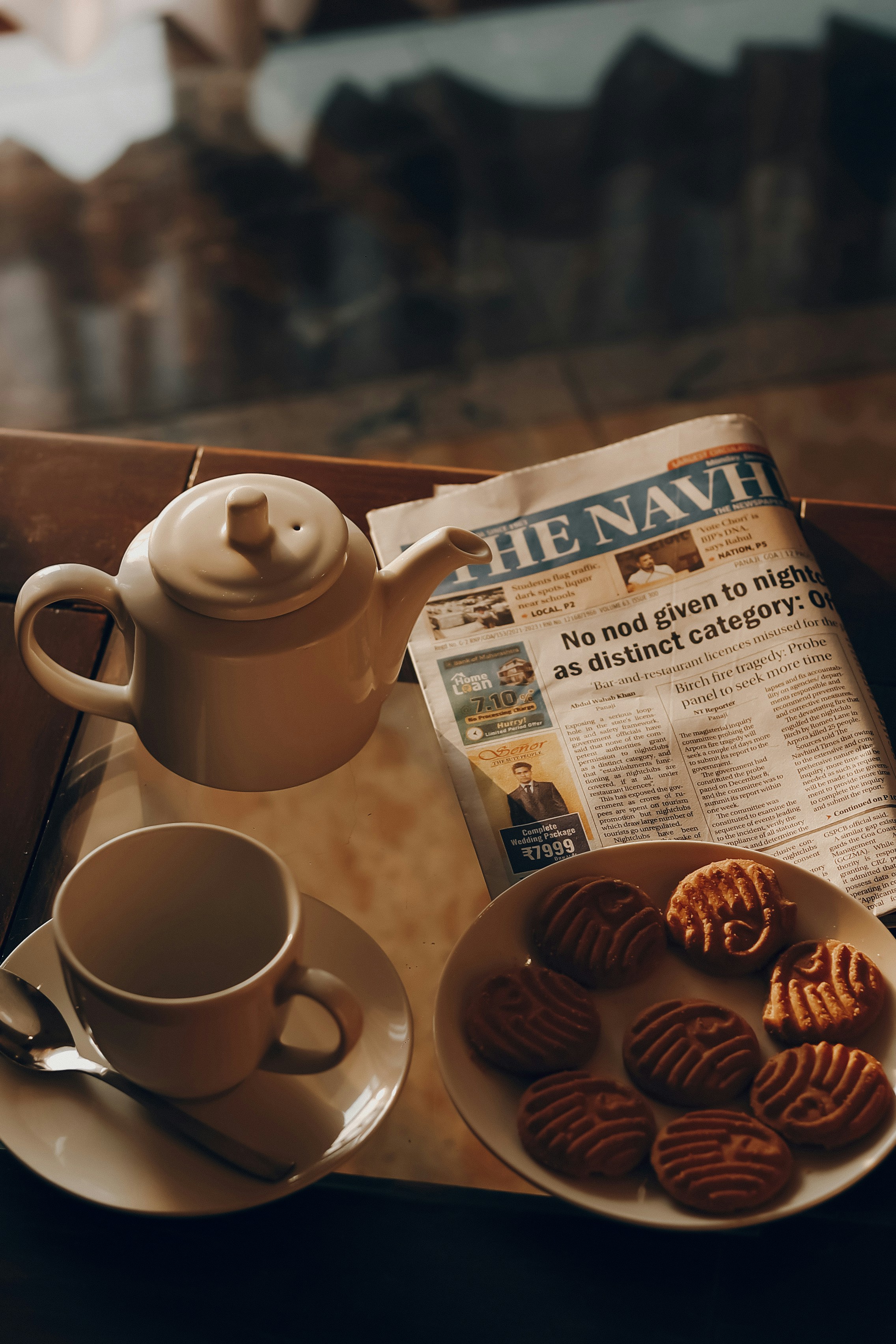 Tea and Temptations: A Quiet Snack Break by the Newspaper