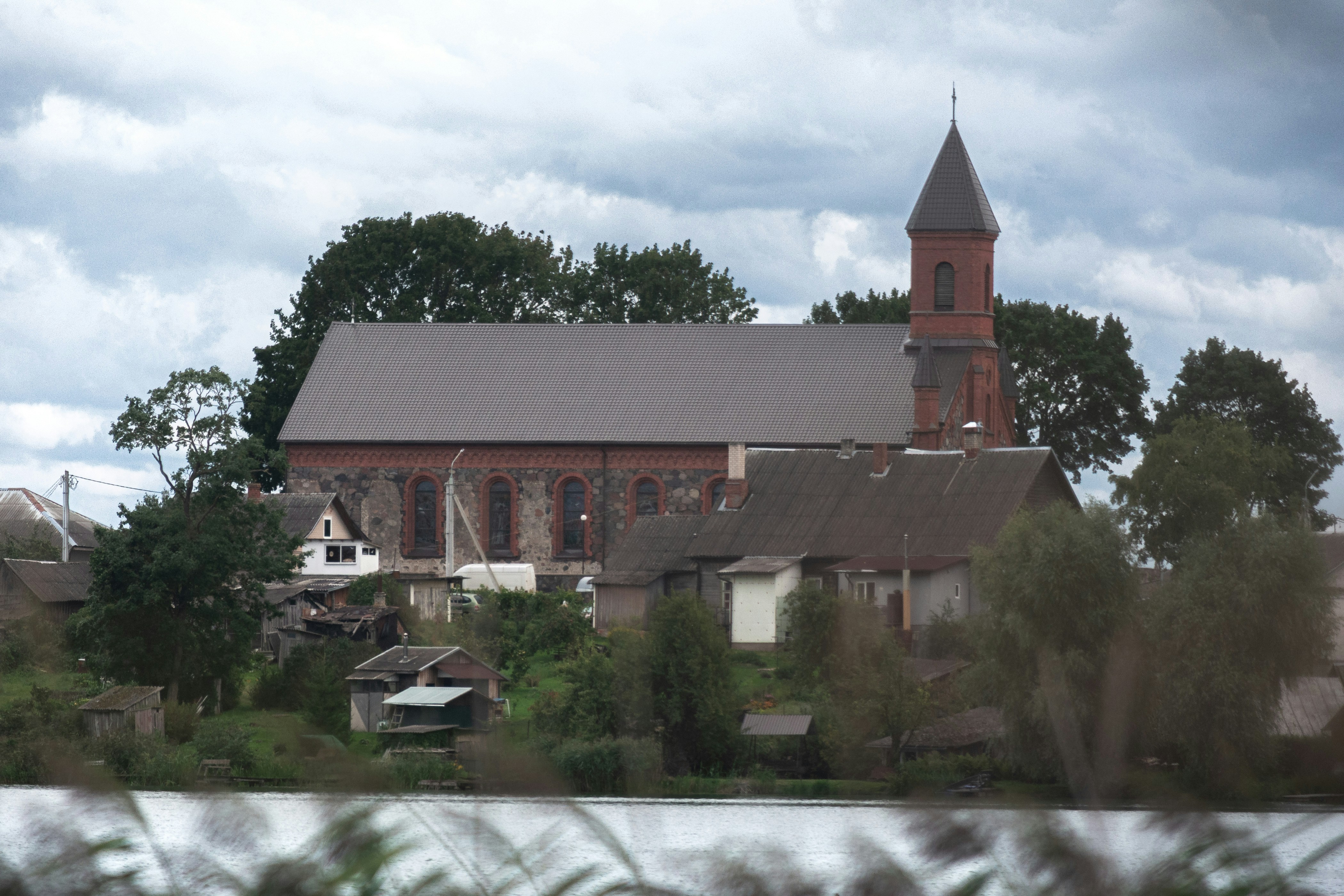 Brick Church on hill: a tranquil village silhouette by the river