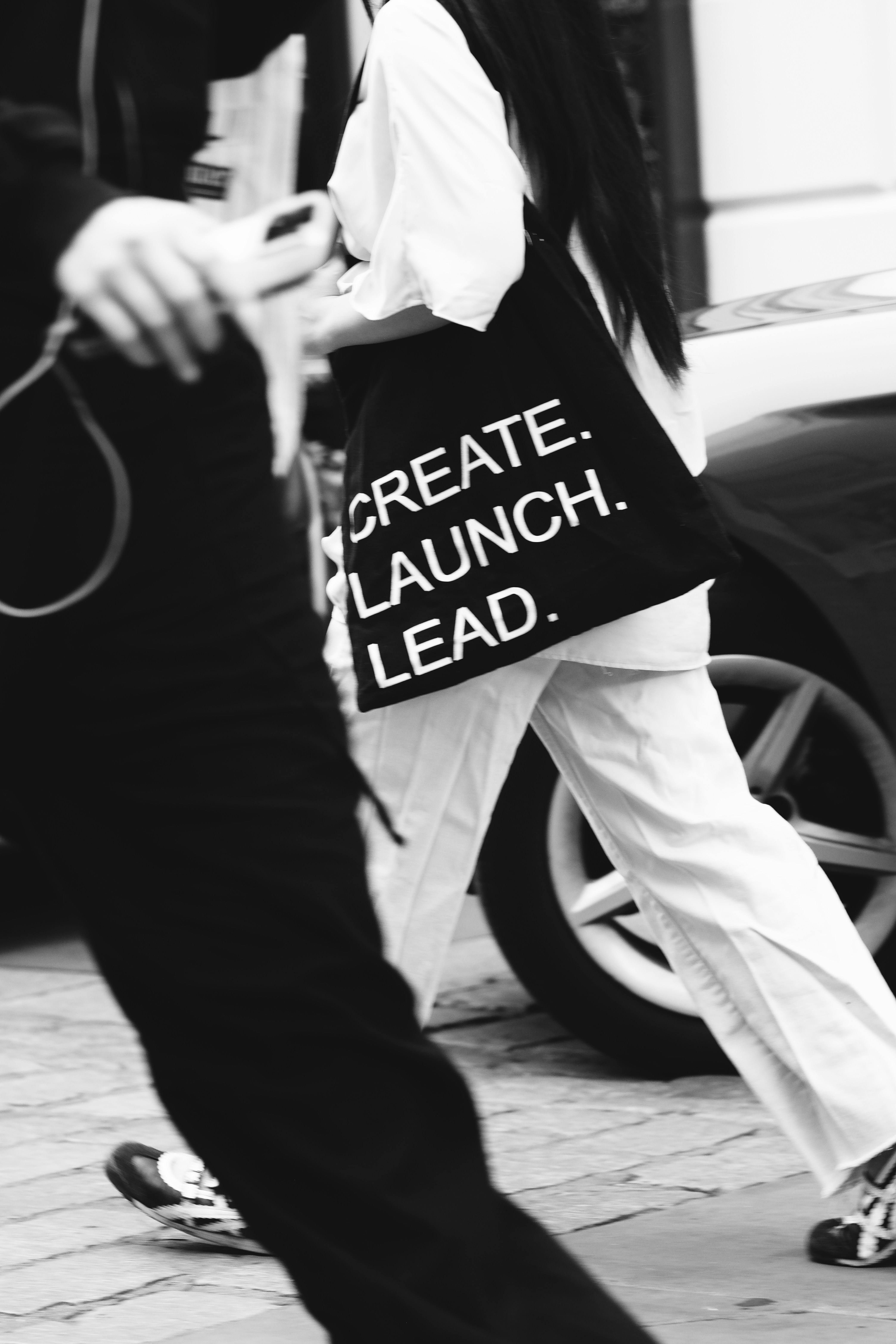Stride and Signage: A Black-and-White Street Moment