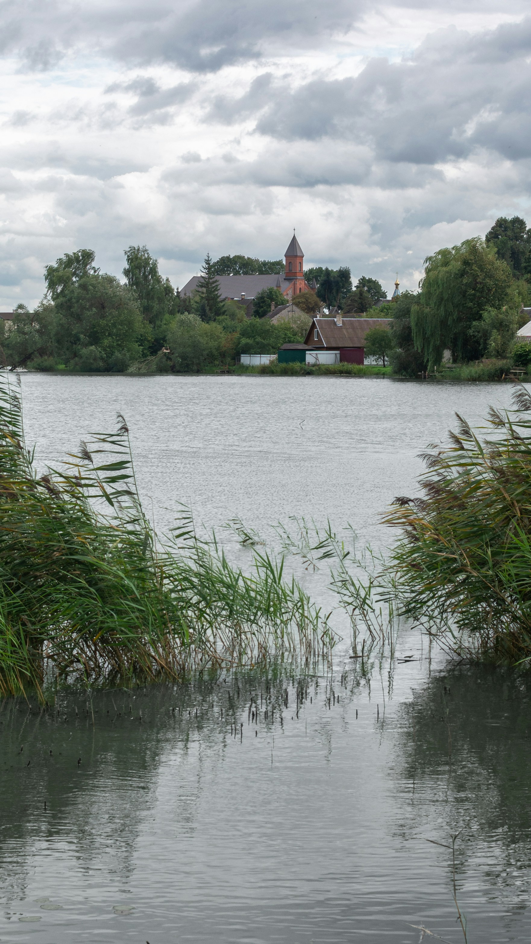 Lakeside Village with Church Spire Peeking Over Trees