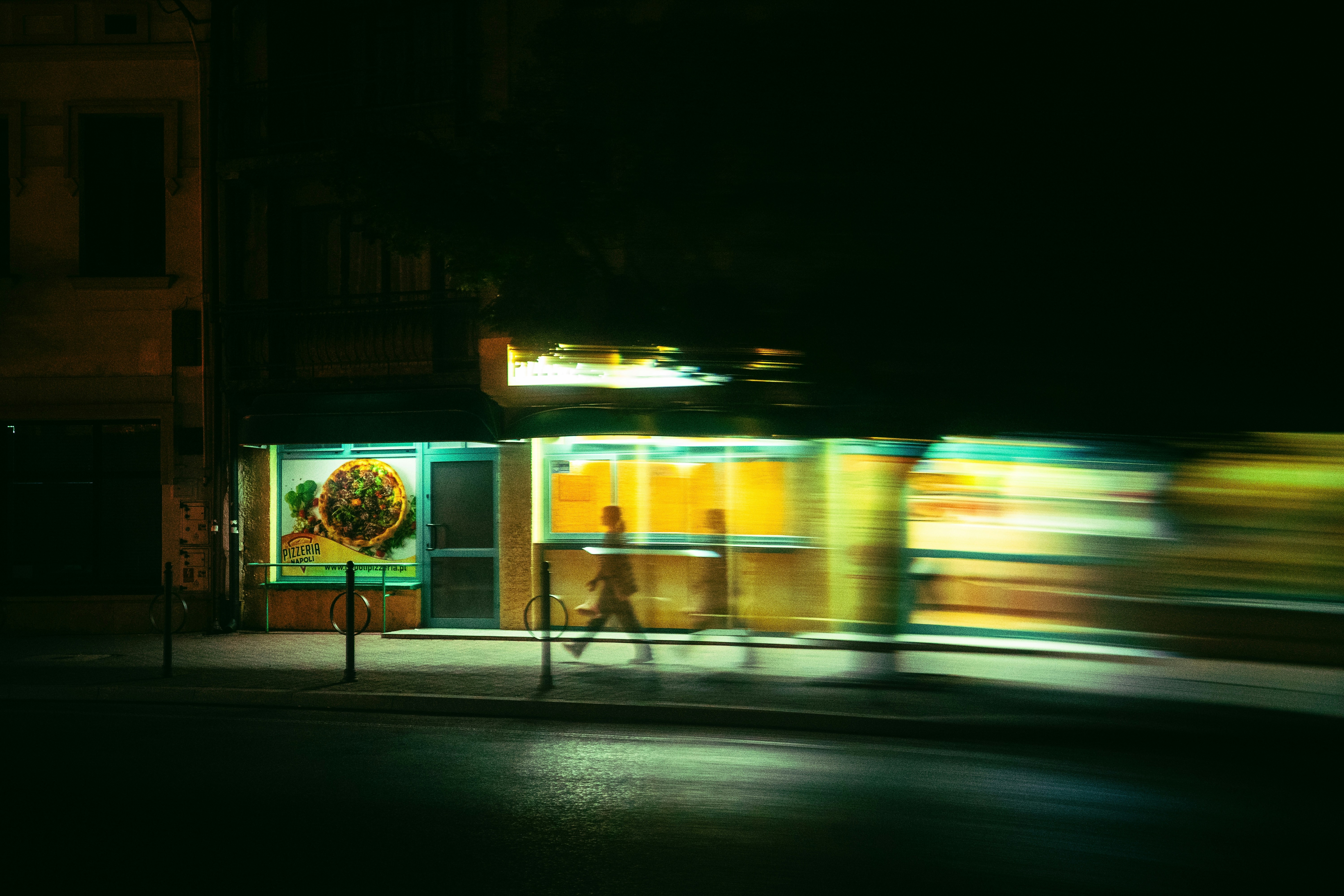Night Street Caravan: A Glimpse of Motion Through a Moving Urban Slice